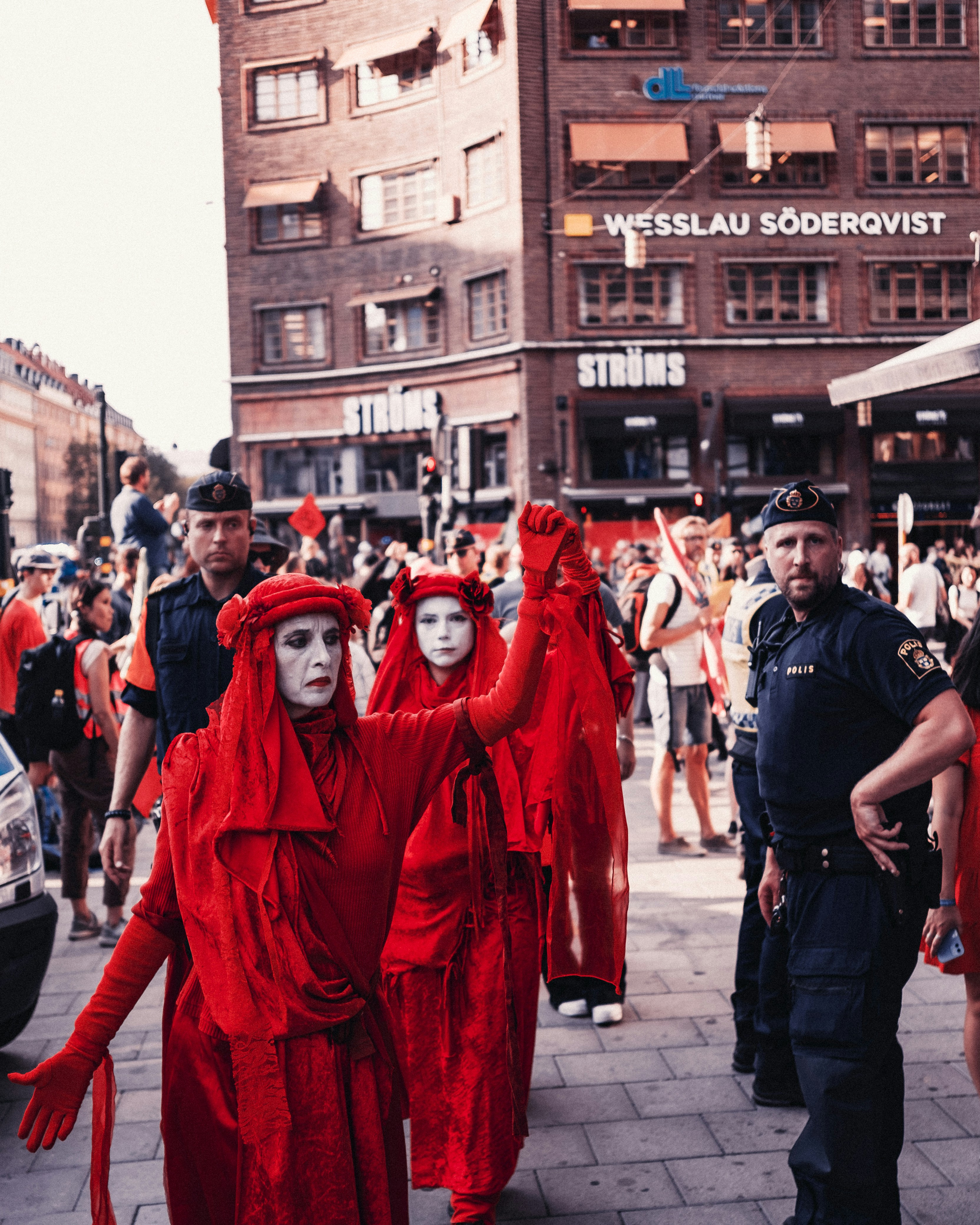 Crimson Parade Amid Urban Backdrop