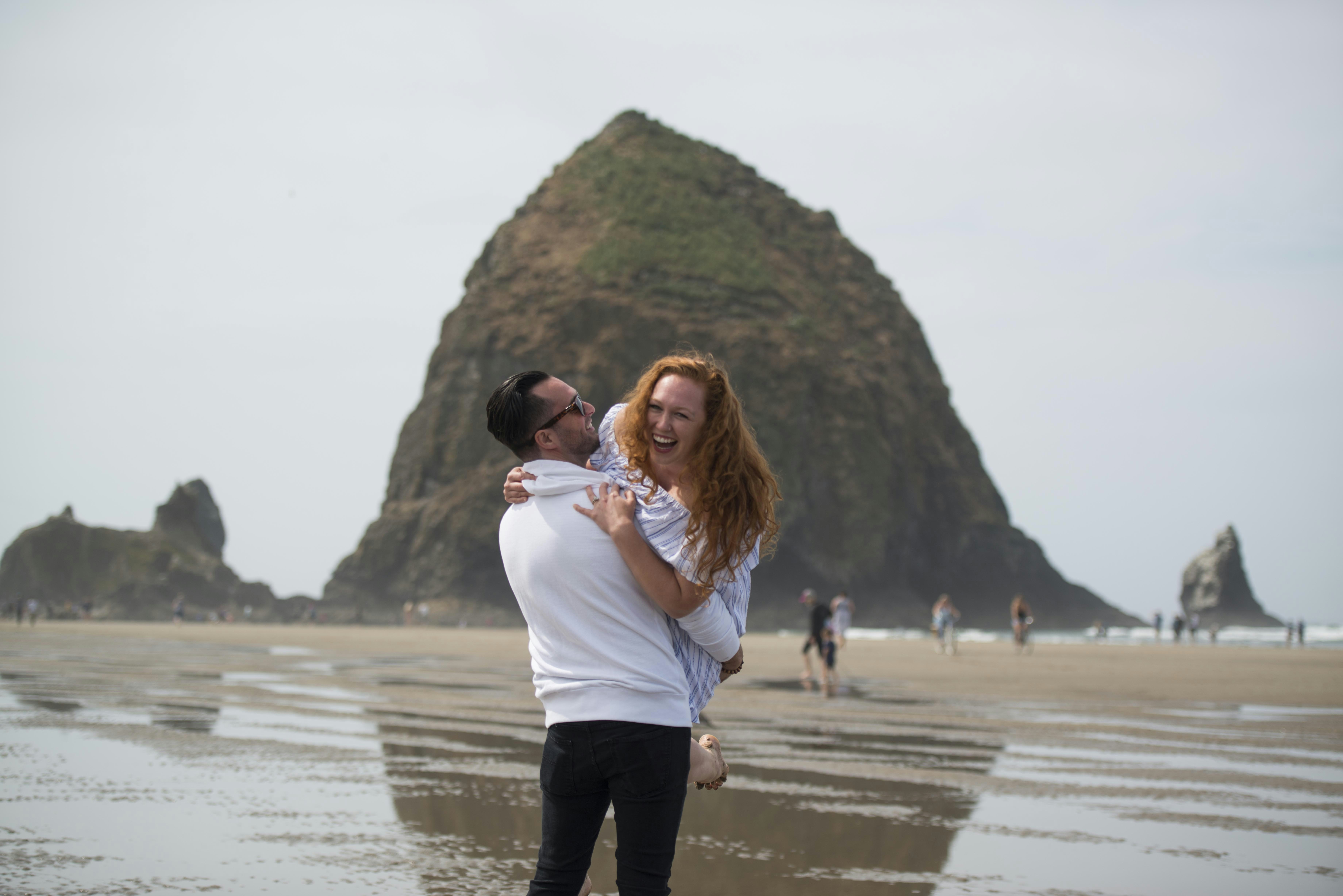 Seaside Embrace Beneath a Stoic Sea Stack