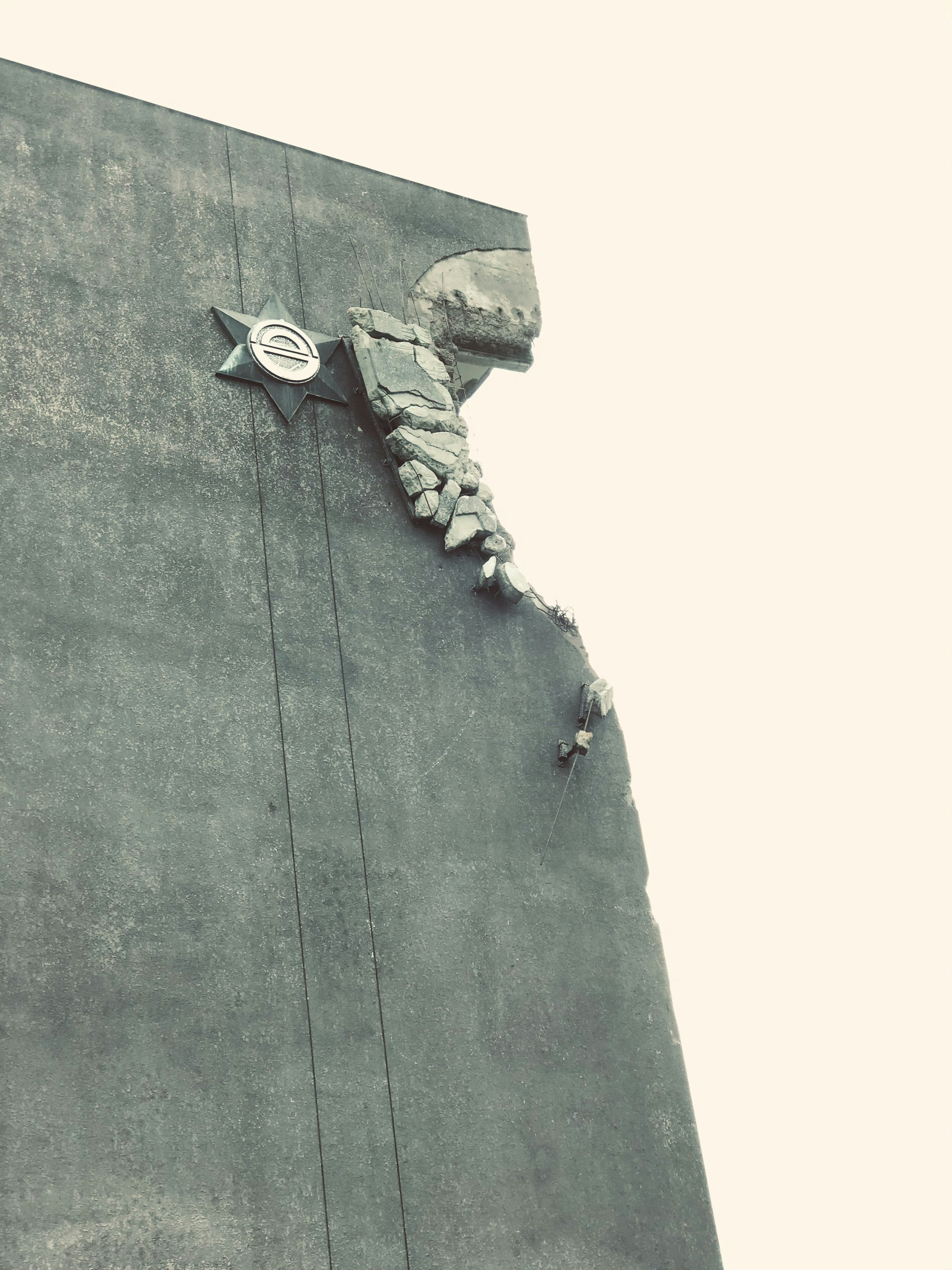 Edge of the Star: A Crumbling Facade Against Pale Sky