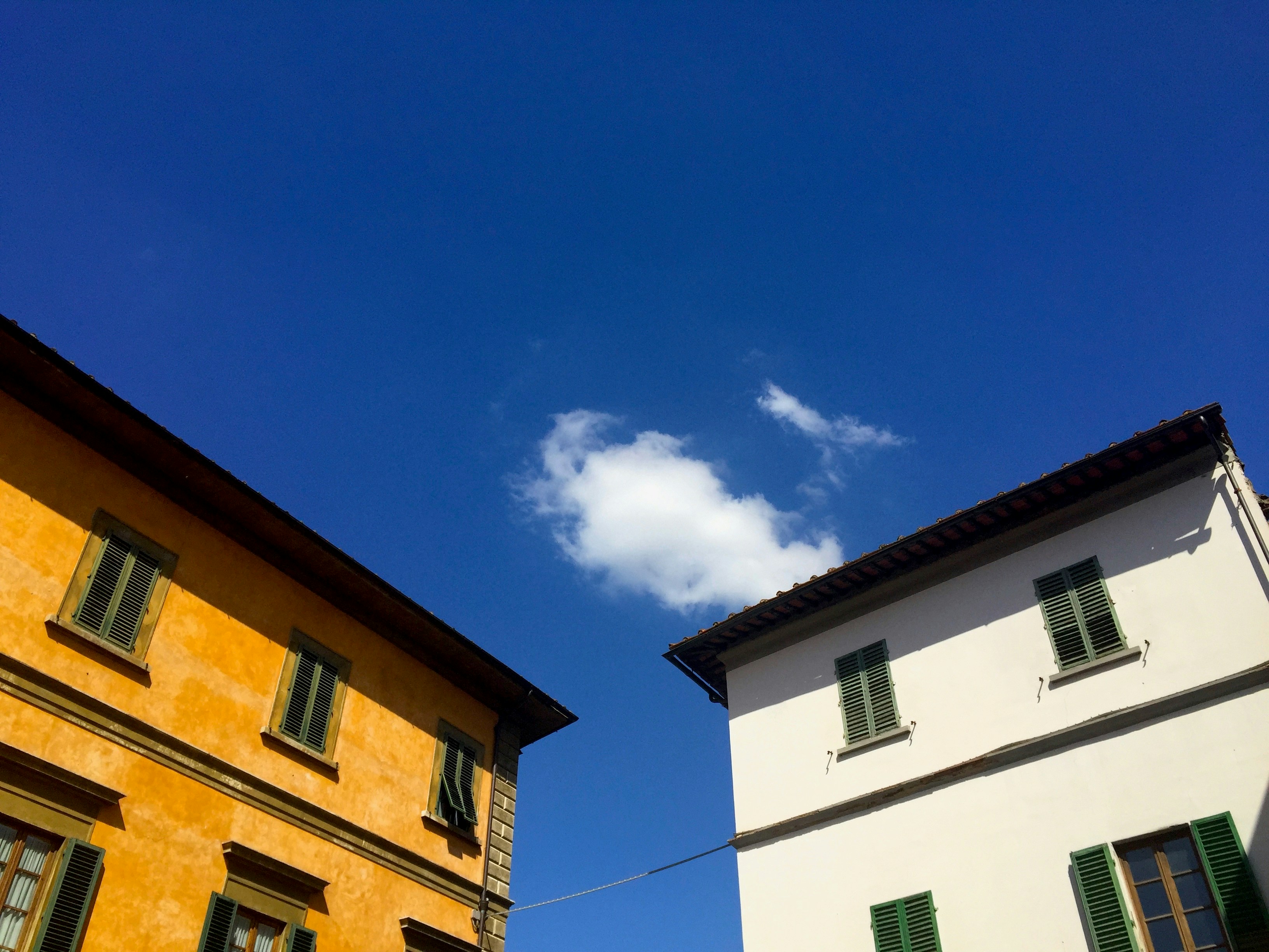 A group of buildings with a blue sky above photo – Free Italy Image on ...