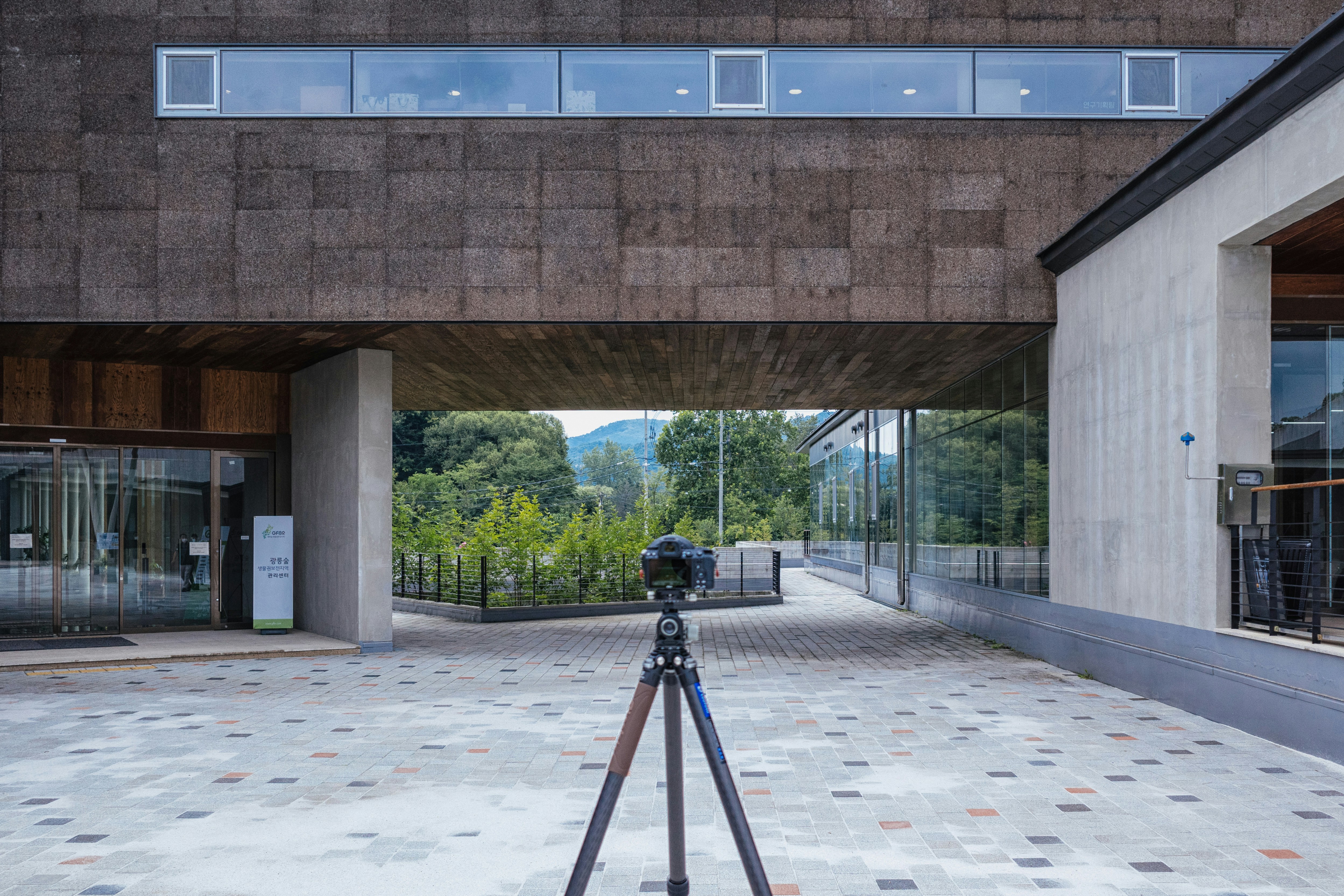A camera on a tripod outside a building photo – Free Architecture Image ...