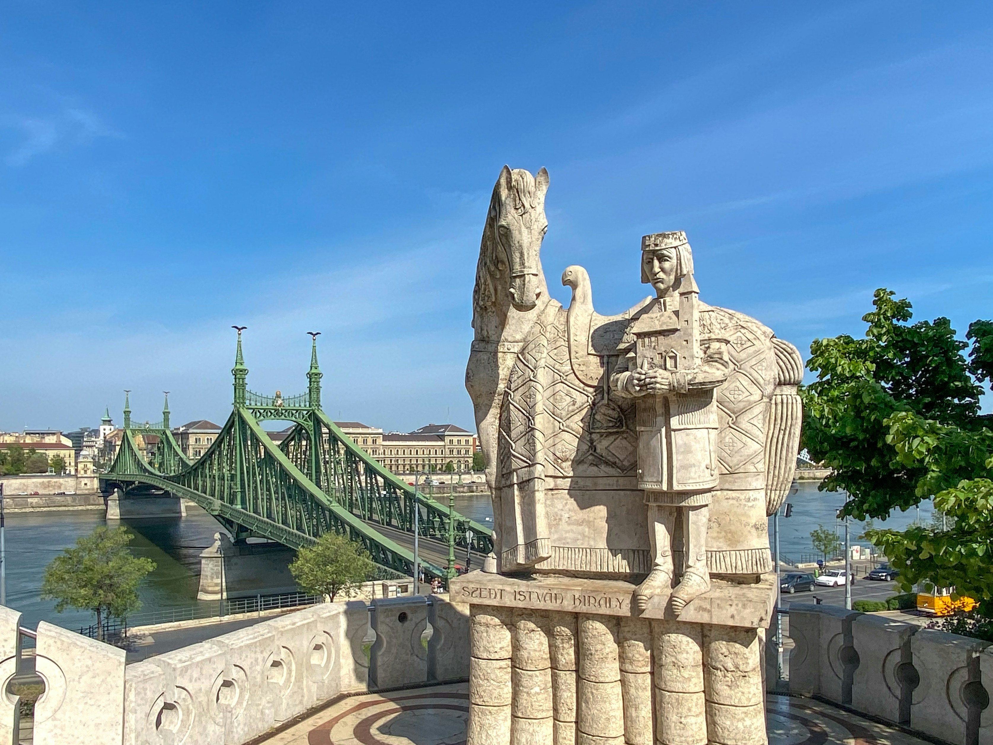 Stone Guardians Over the Danube: Statue, Bridge, and Riverfront
