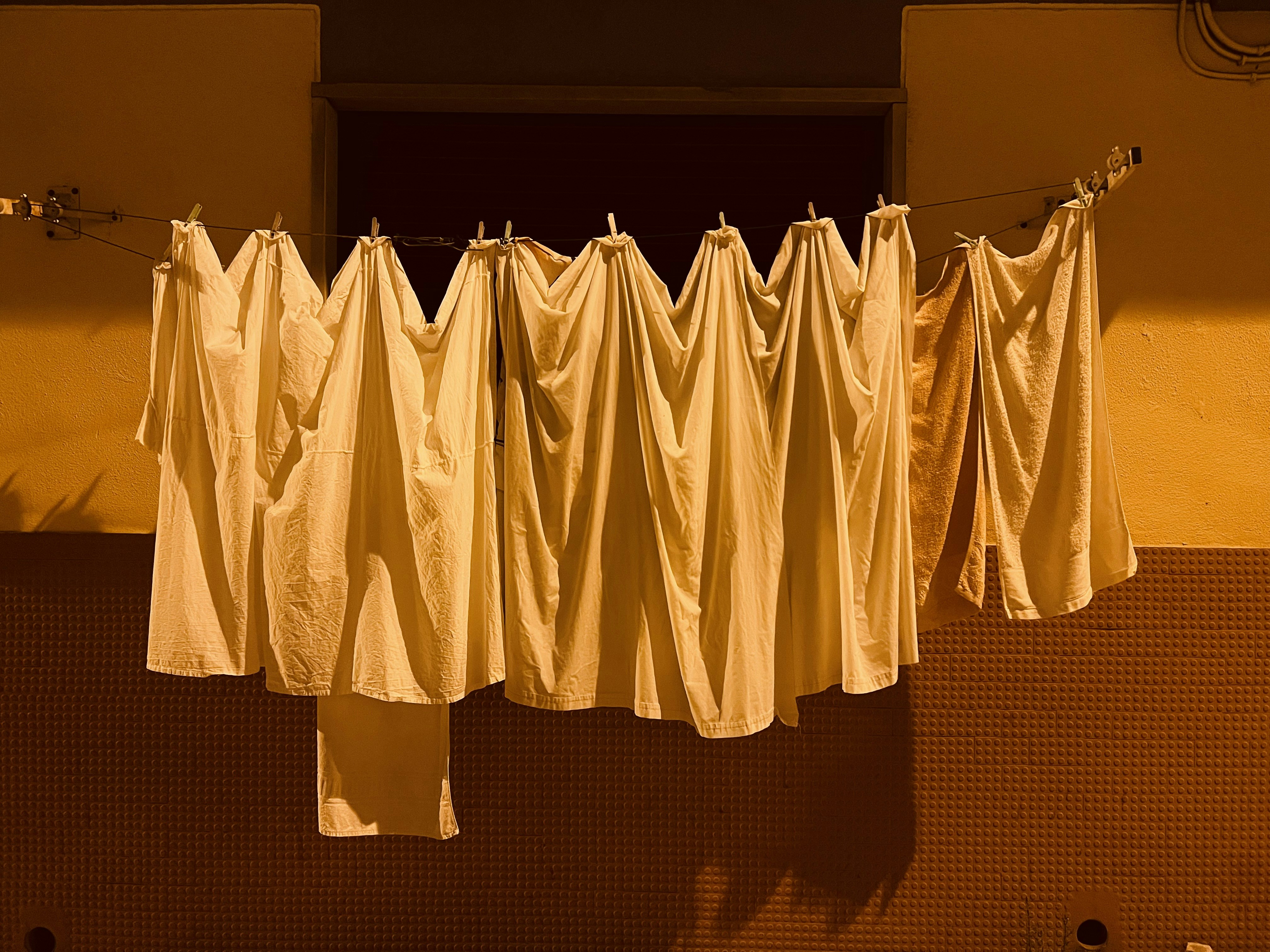 a row of white curtains on a line