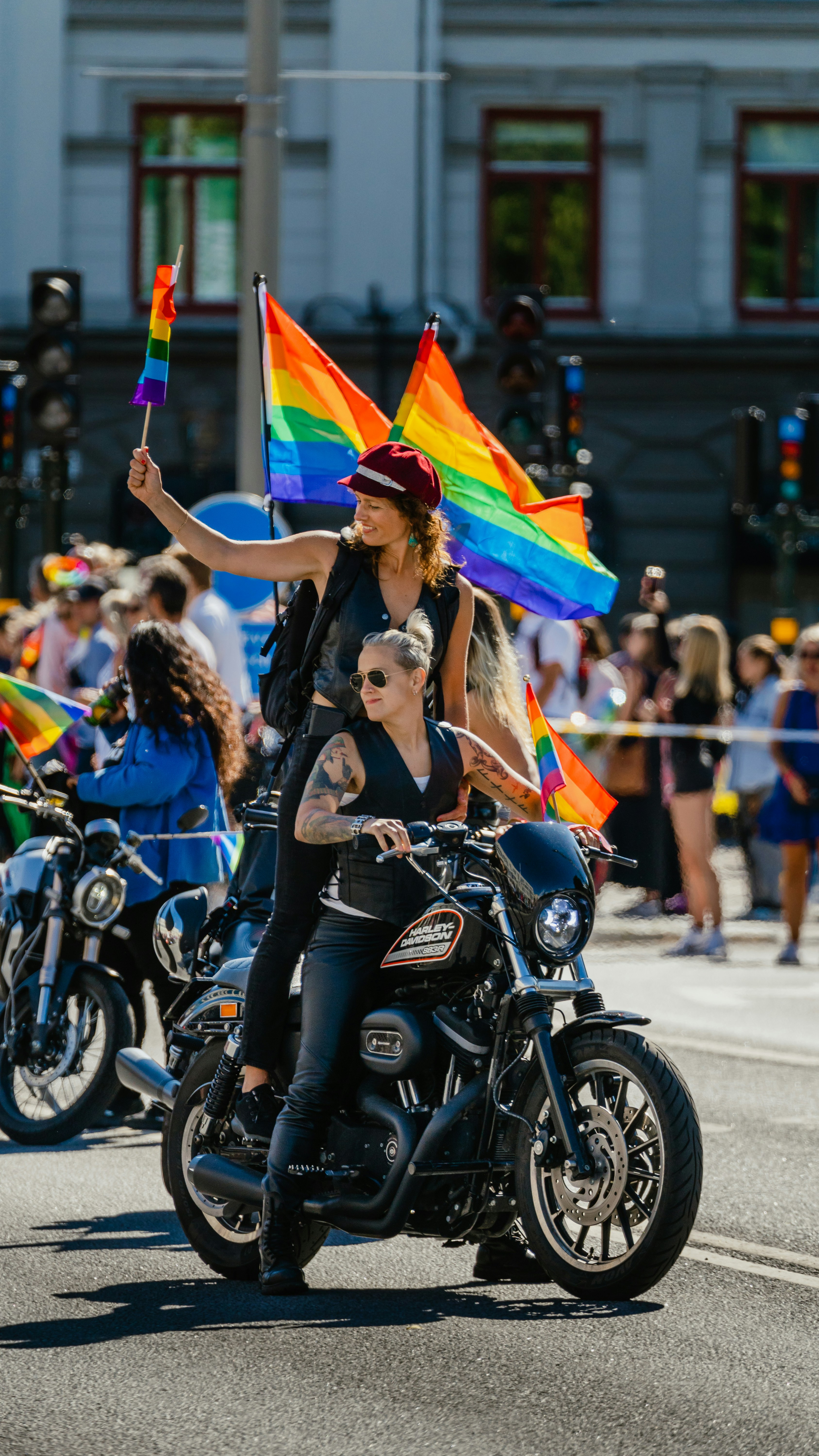 A couple of women riding a motorcycle with flags photo – Free Current ...