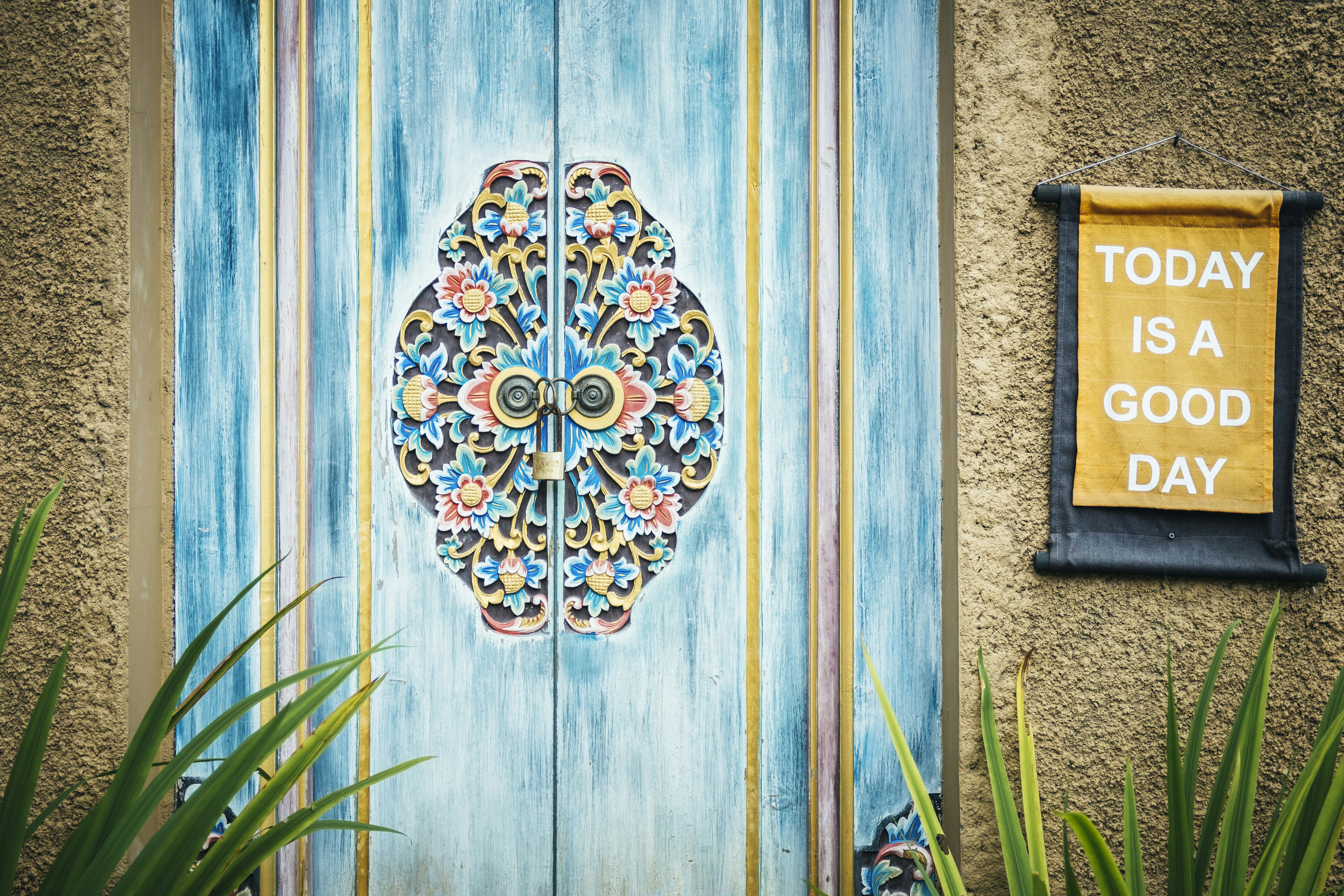 Ornate door centerpiece framed by sunlit signage