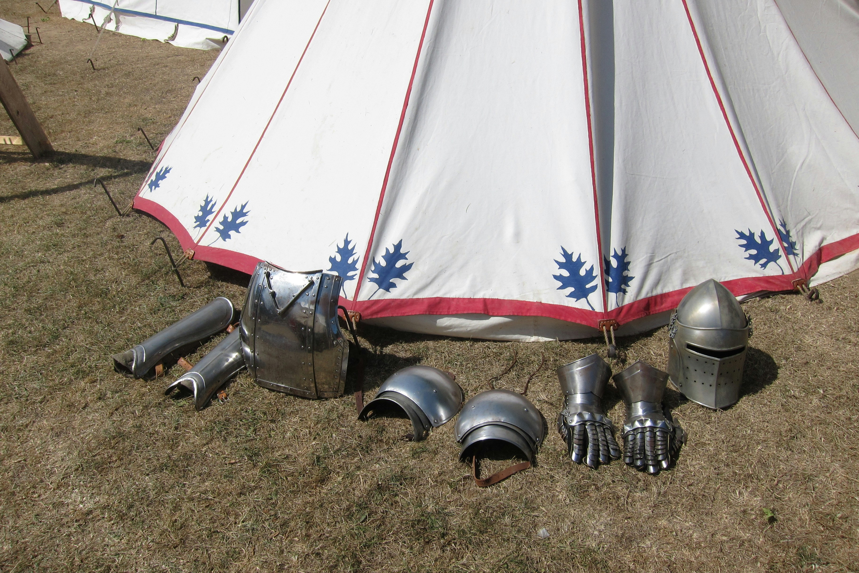 Heraldic Gear Beside a Tented Camp