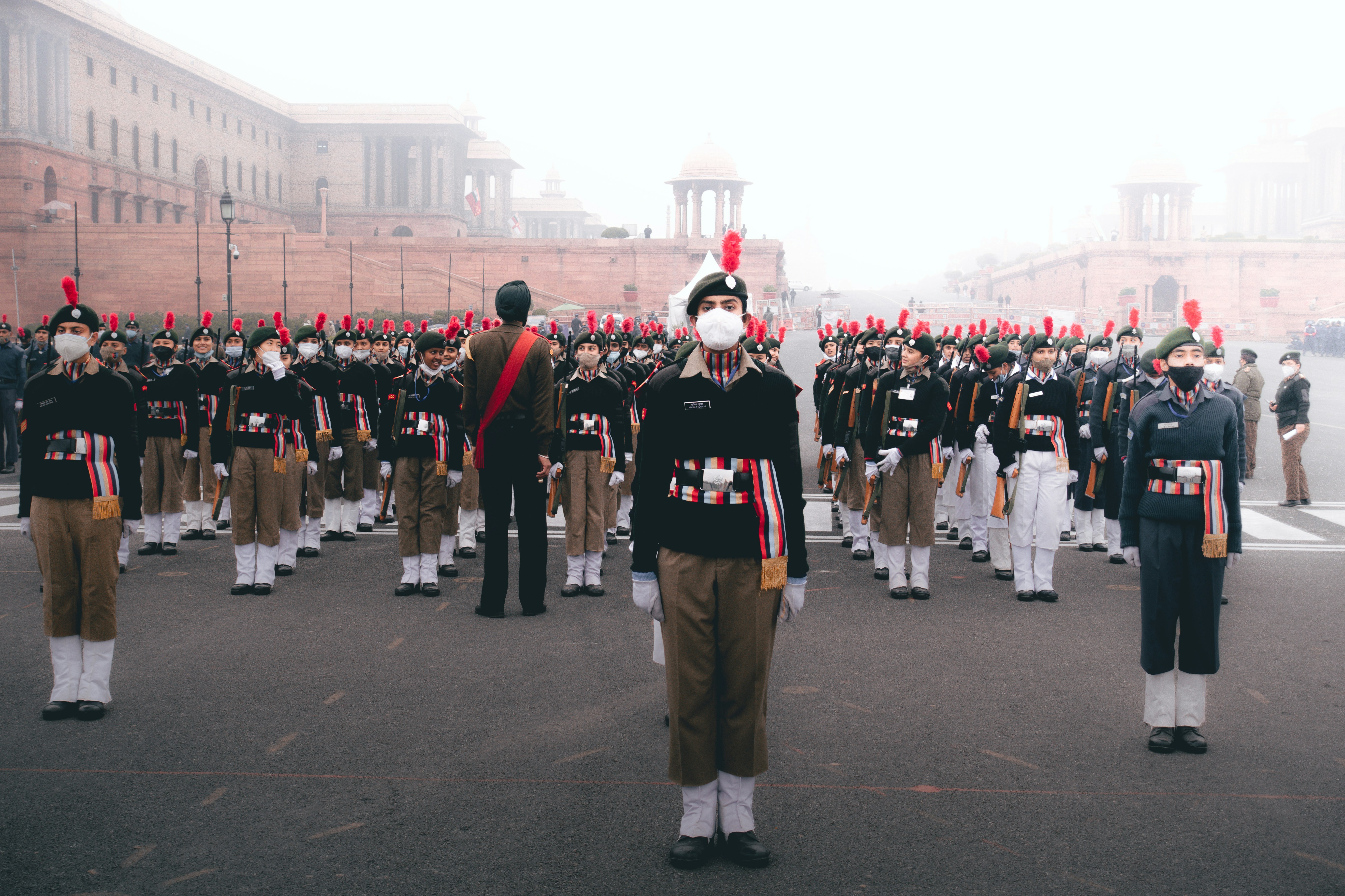 A group of people in uniform marching photo – Free Marching Image on ...