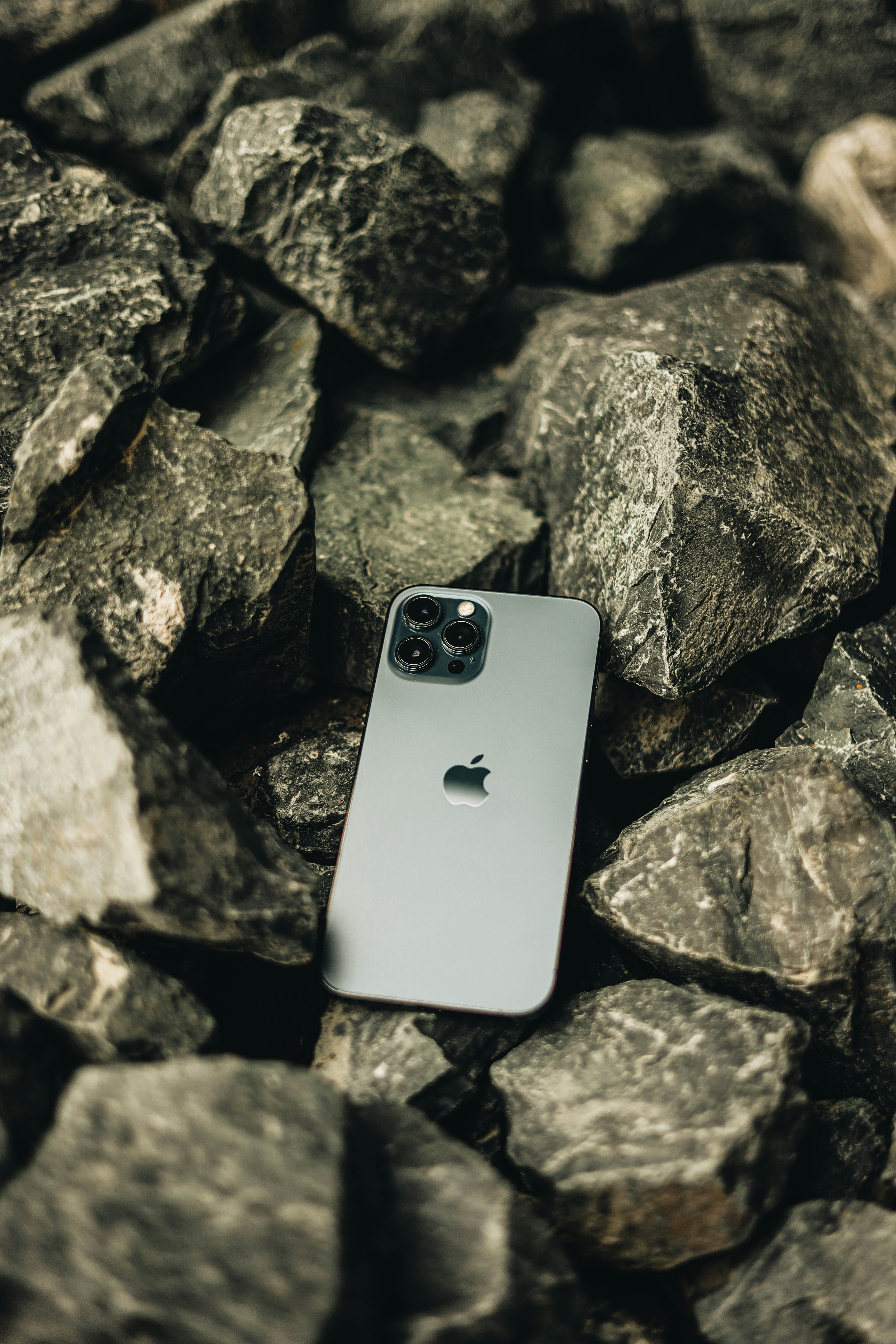 Silvery iPhone Resting Among Jagged Rocks