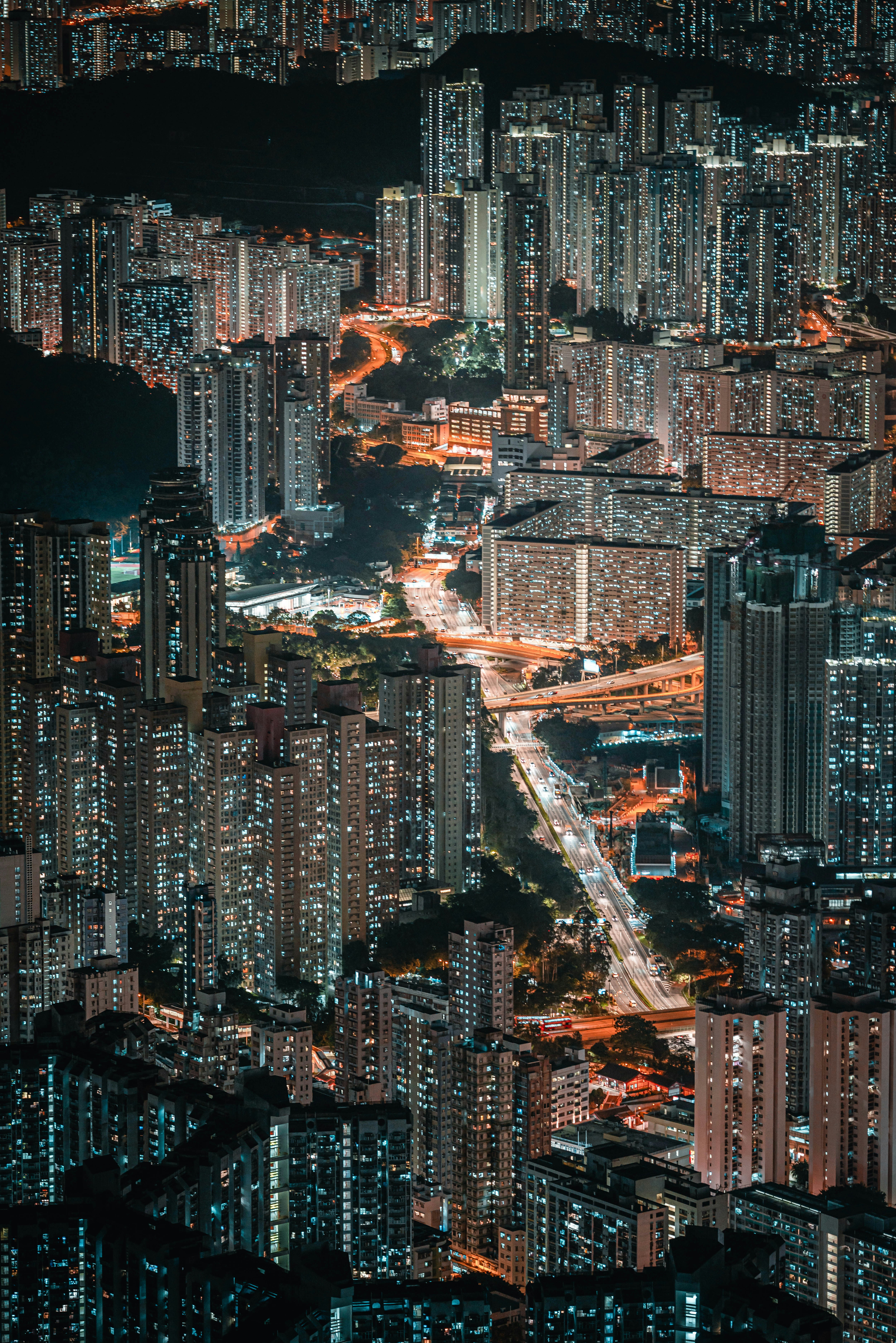 Vast cityscape illuminated by countless windows and streetlights, showcasing the vibrant pulse of urban life at night.
