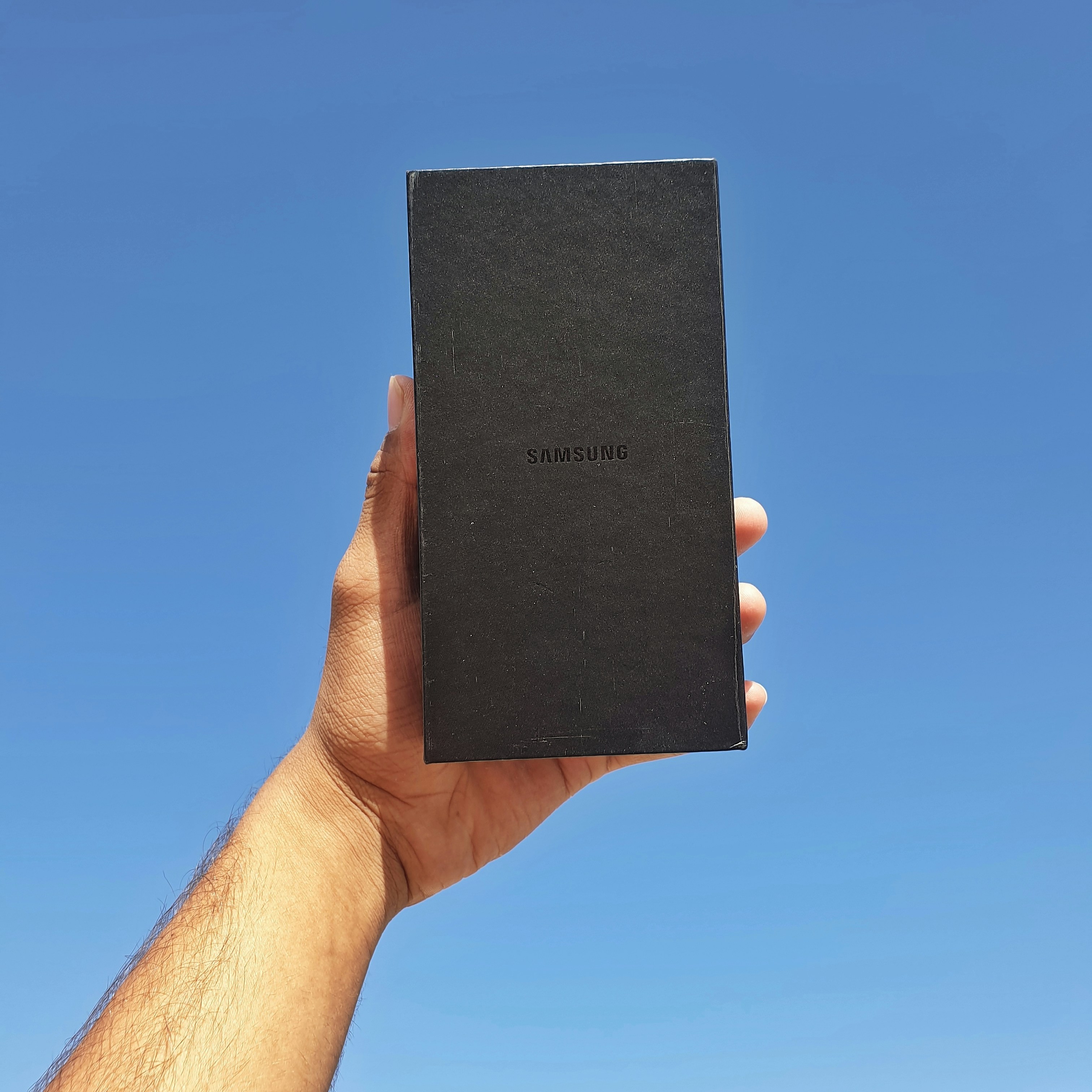 A hand holding a black rectangular device photo – Free Gandhinagar ...