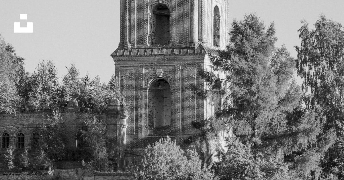 Foto Un Edificio Alto Con Una Torre Imagen Gris Gratis En Unsplash