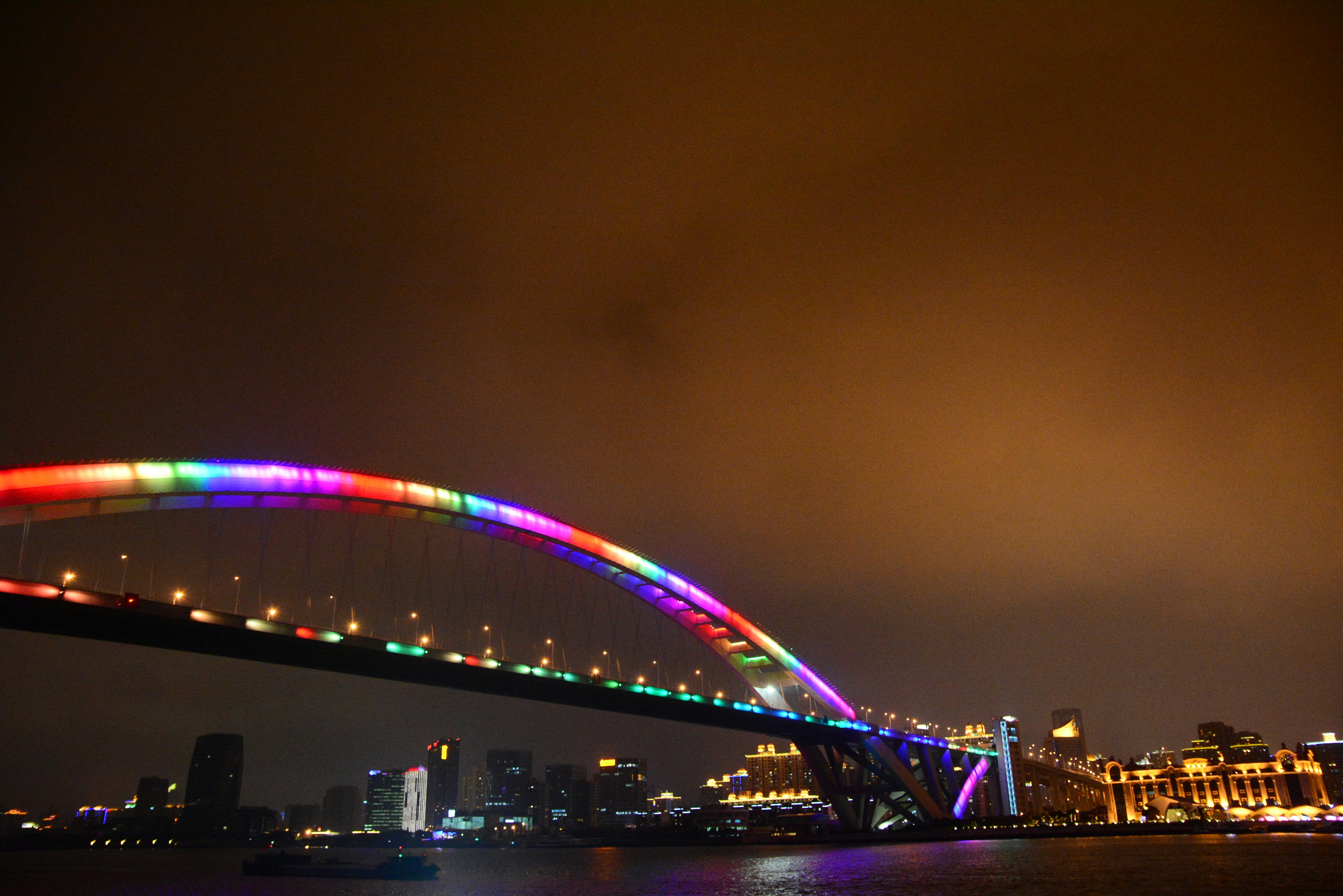 Chromatic Arch Over the River: Night Bridgescape with Neon Rainbow
