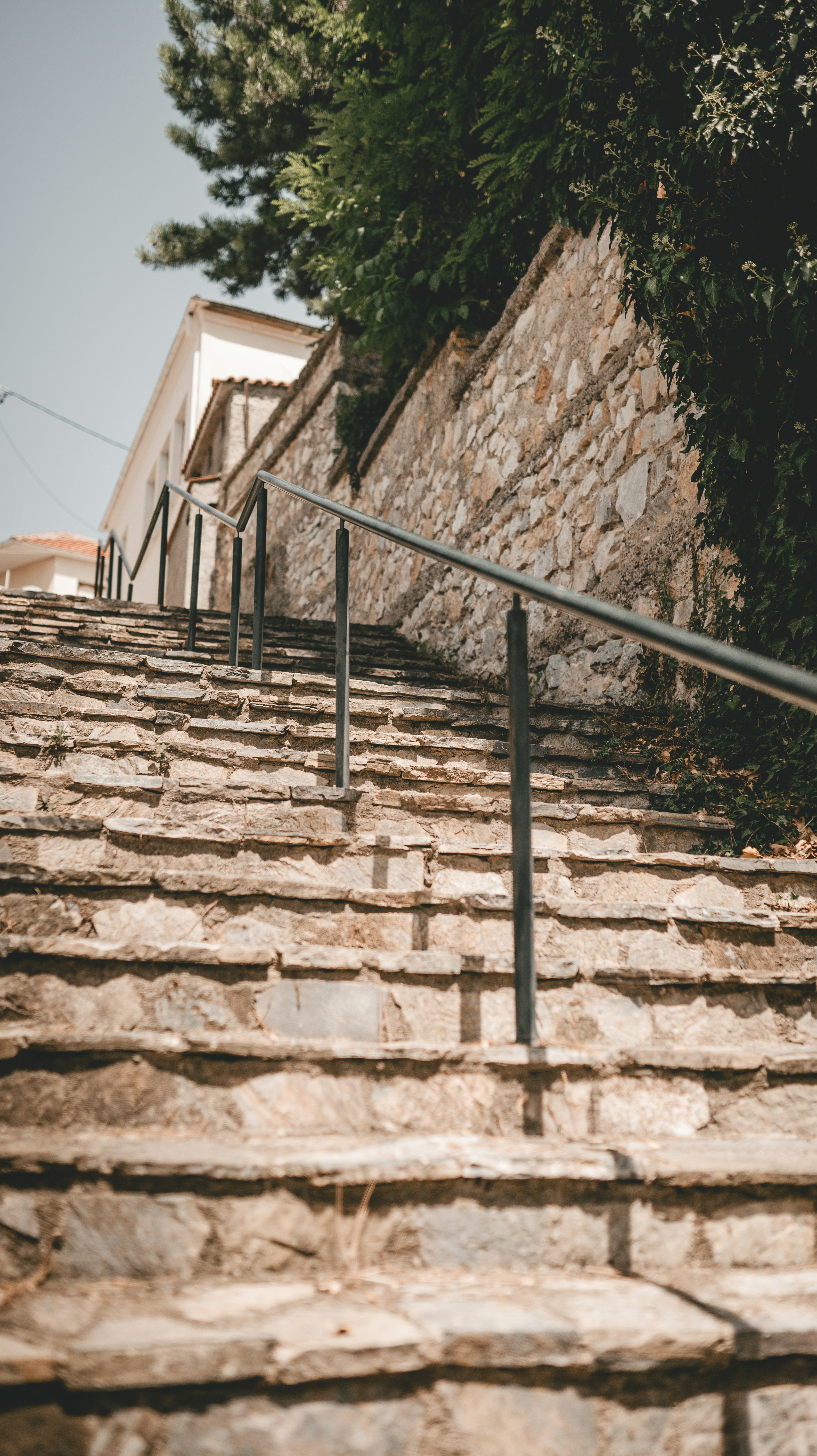 A stone wall with a railing photo – Free Handrail Image on Unsplash