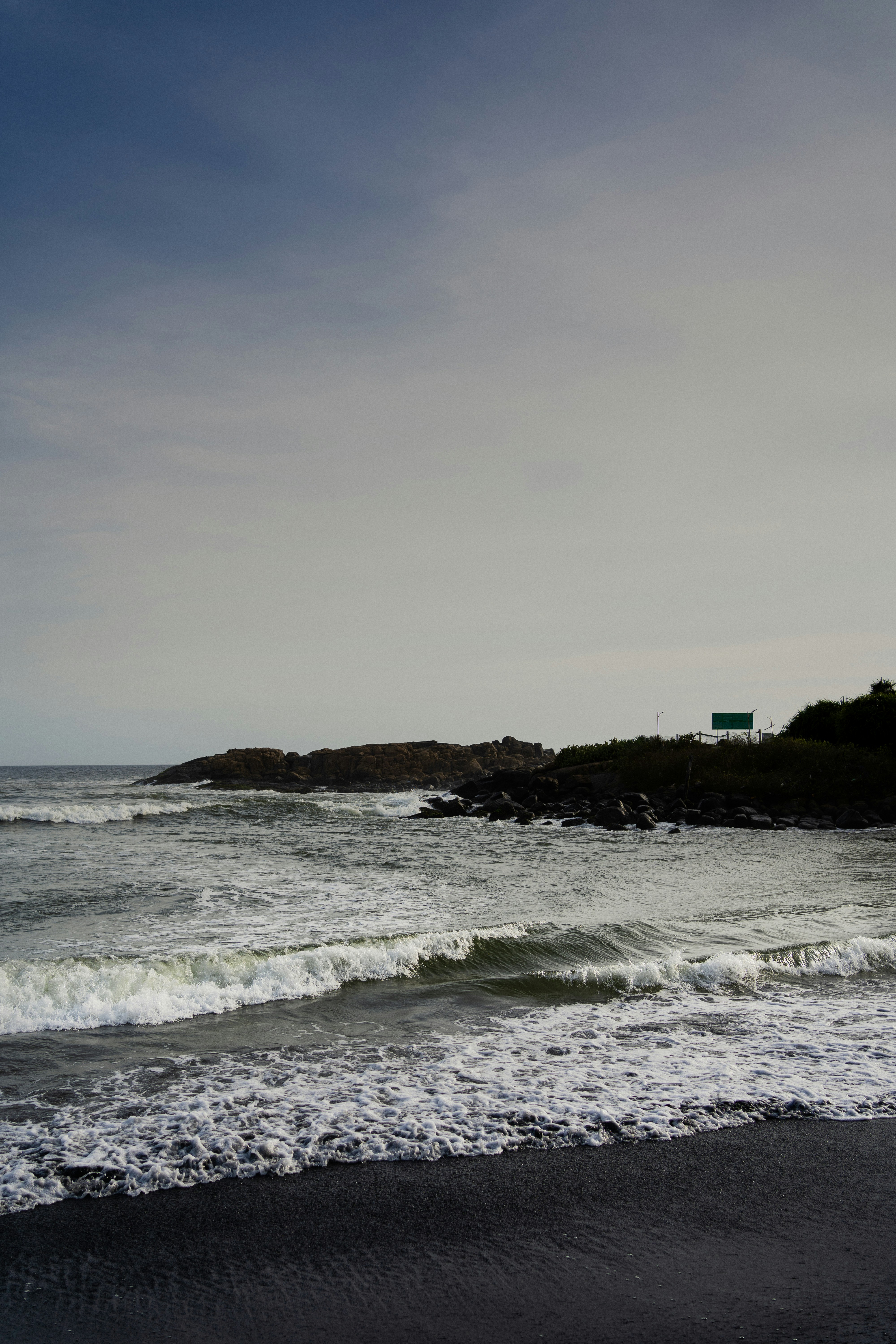 Coastal Breakers and Quiet Jetty at Dusk