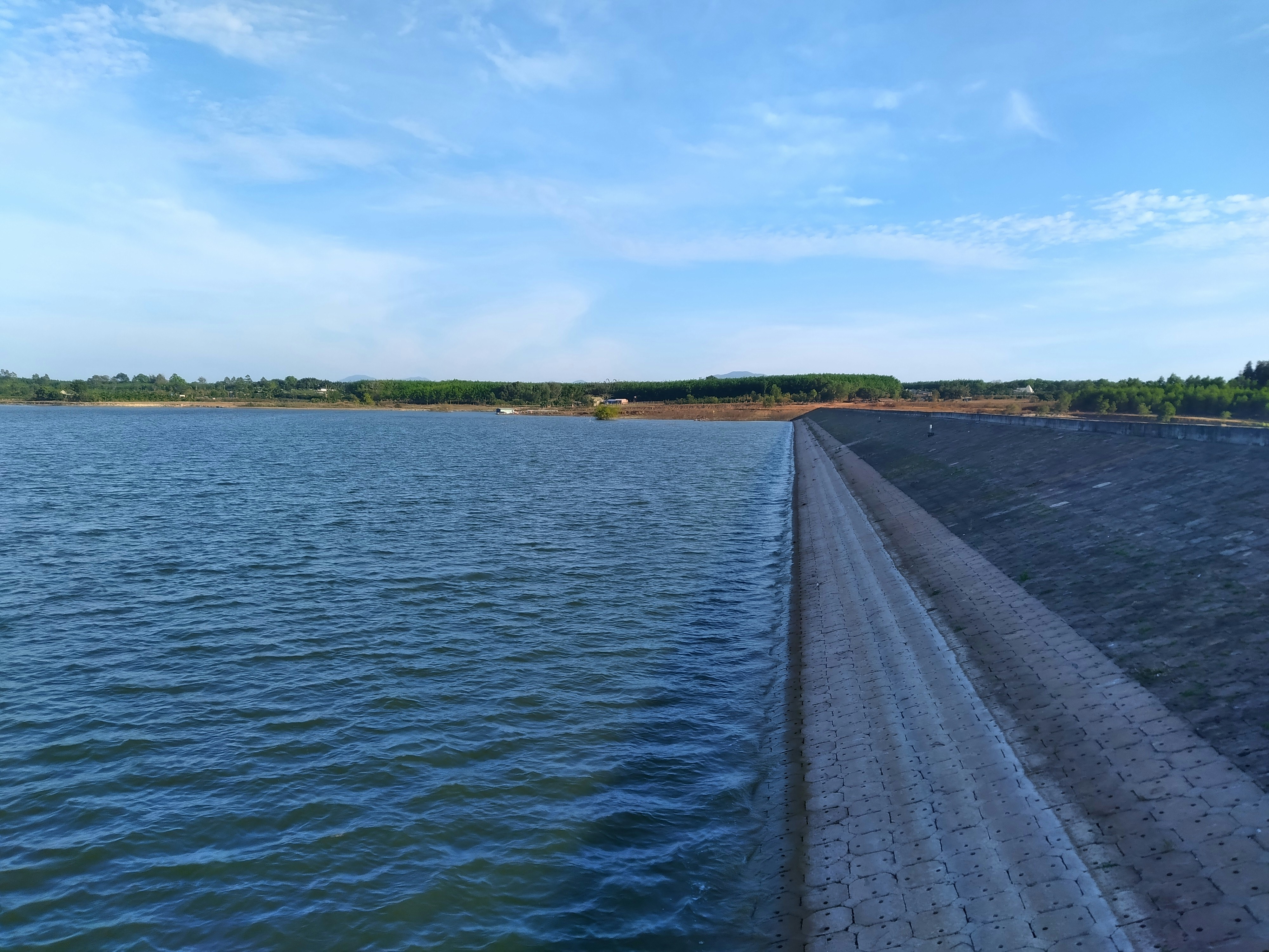Damscape at Sea's Edge: A Concrete Spine Toward the Distant Shore