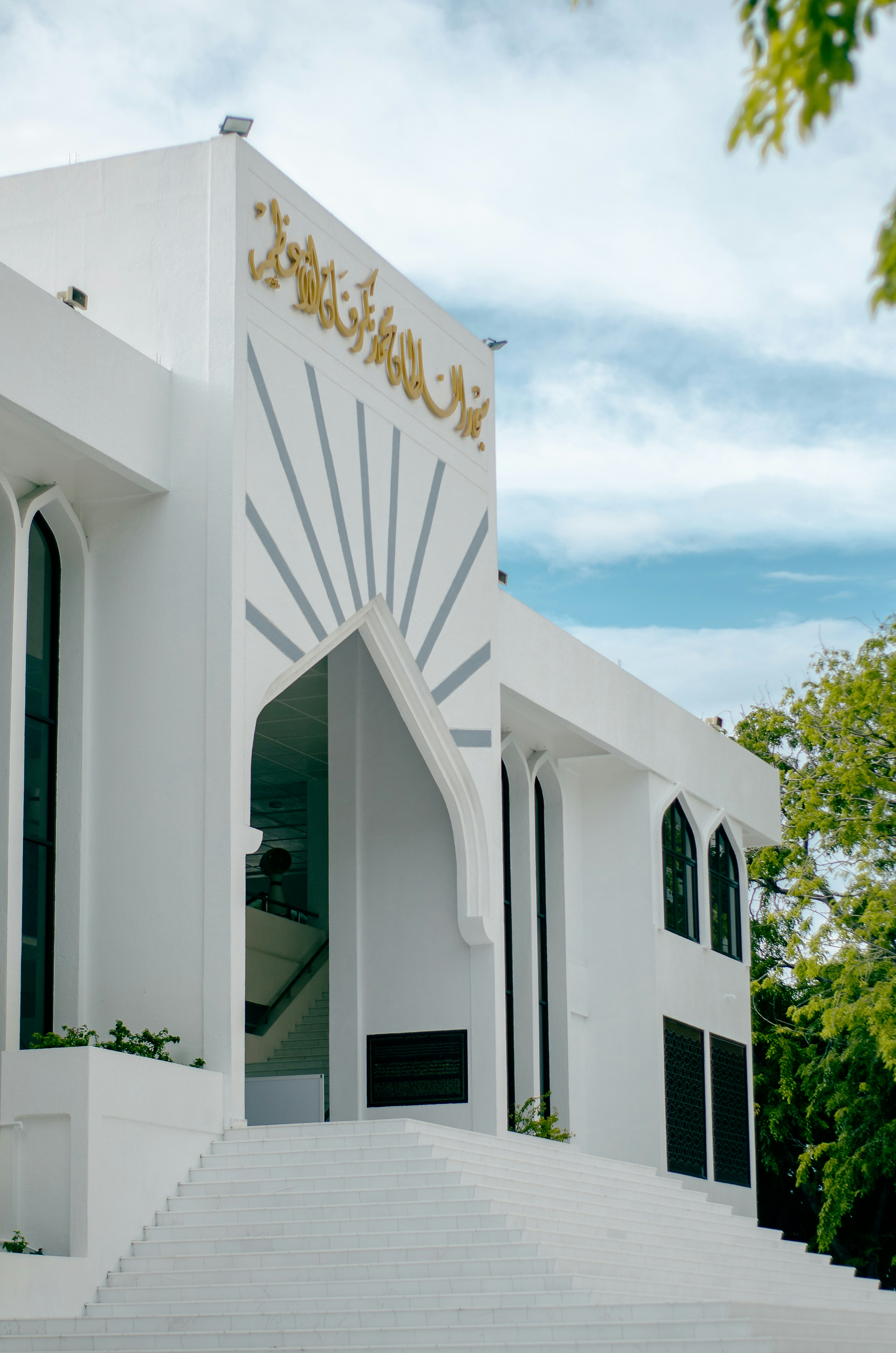 Sunburst Archway on a White Facade: Staircase to Light