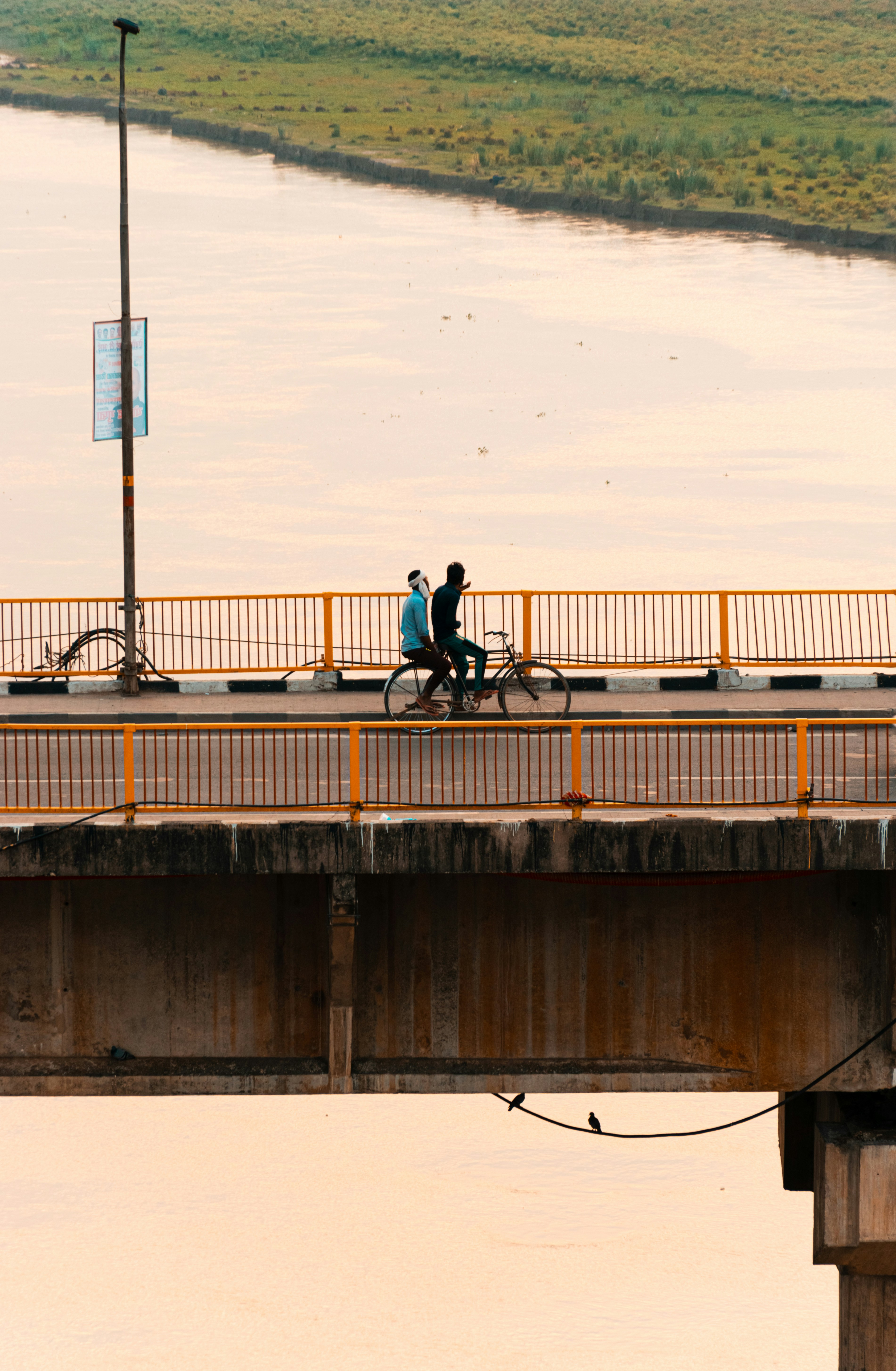 Pedal Partners on a Bridge at Dusk