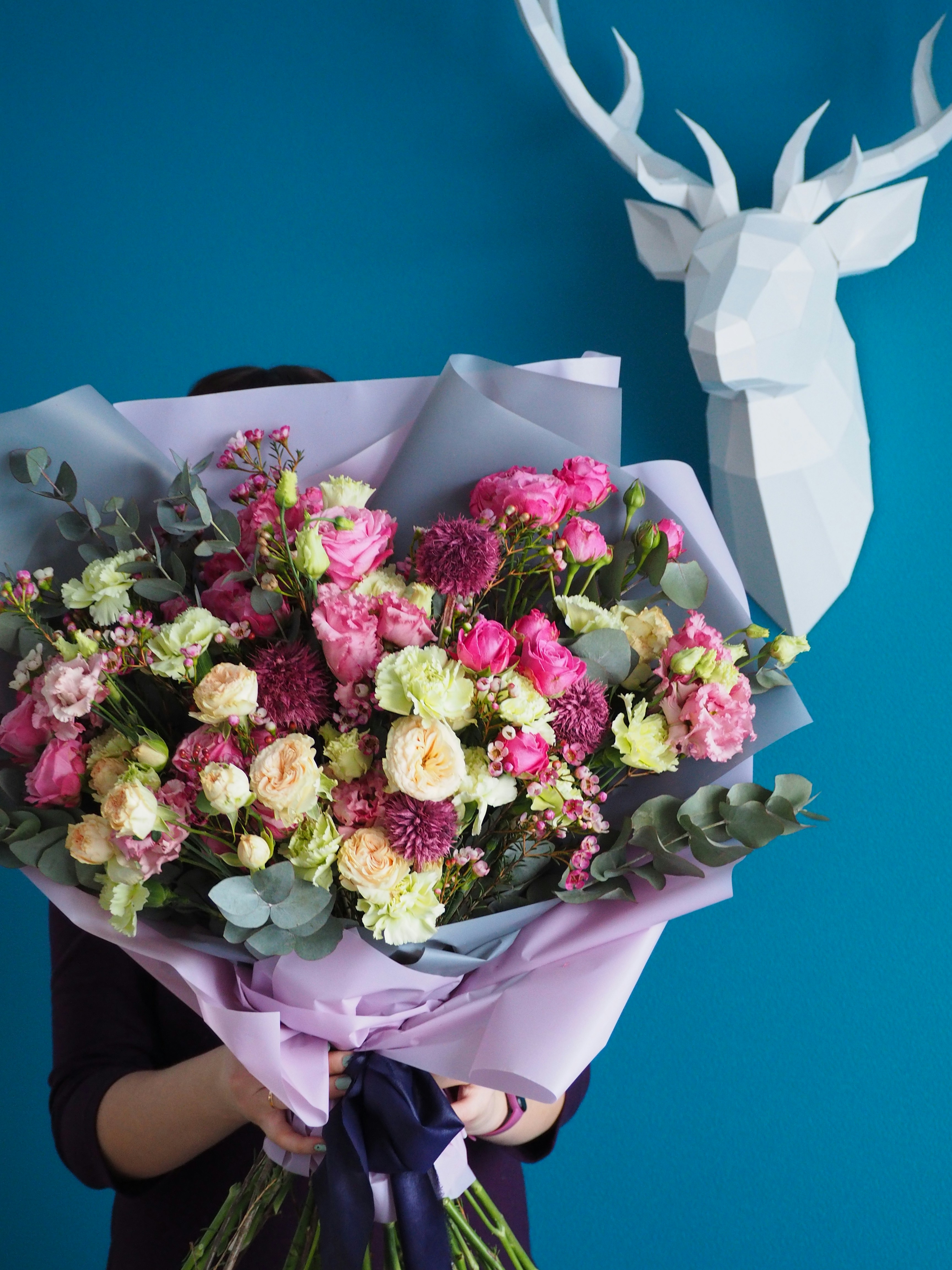 Pastel Bouquet Framed by a Geometric White Deer on a Cerulean Wall