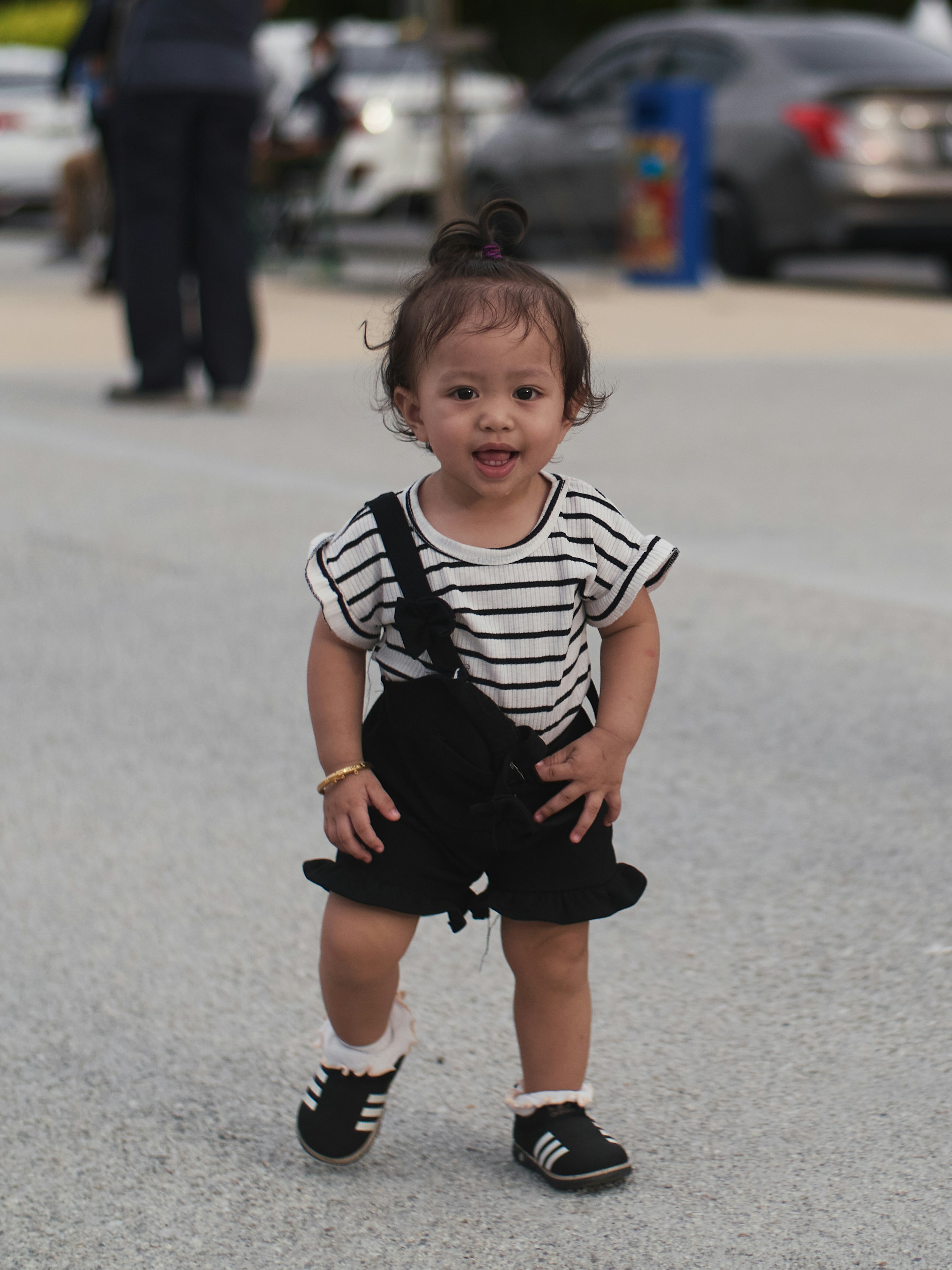 a little girl standing on a street