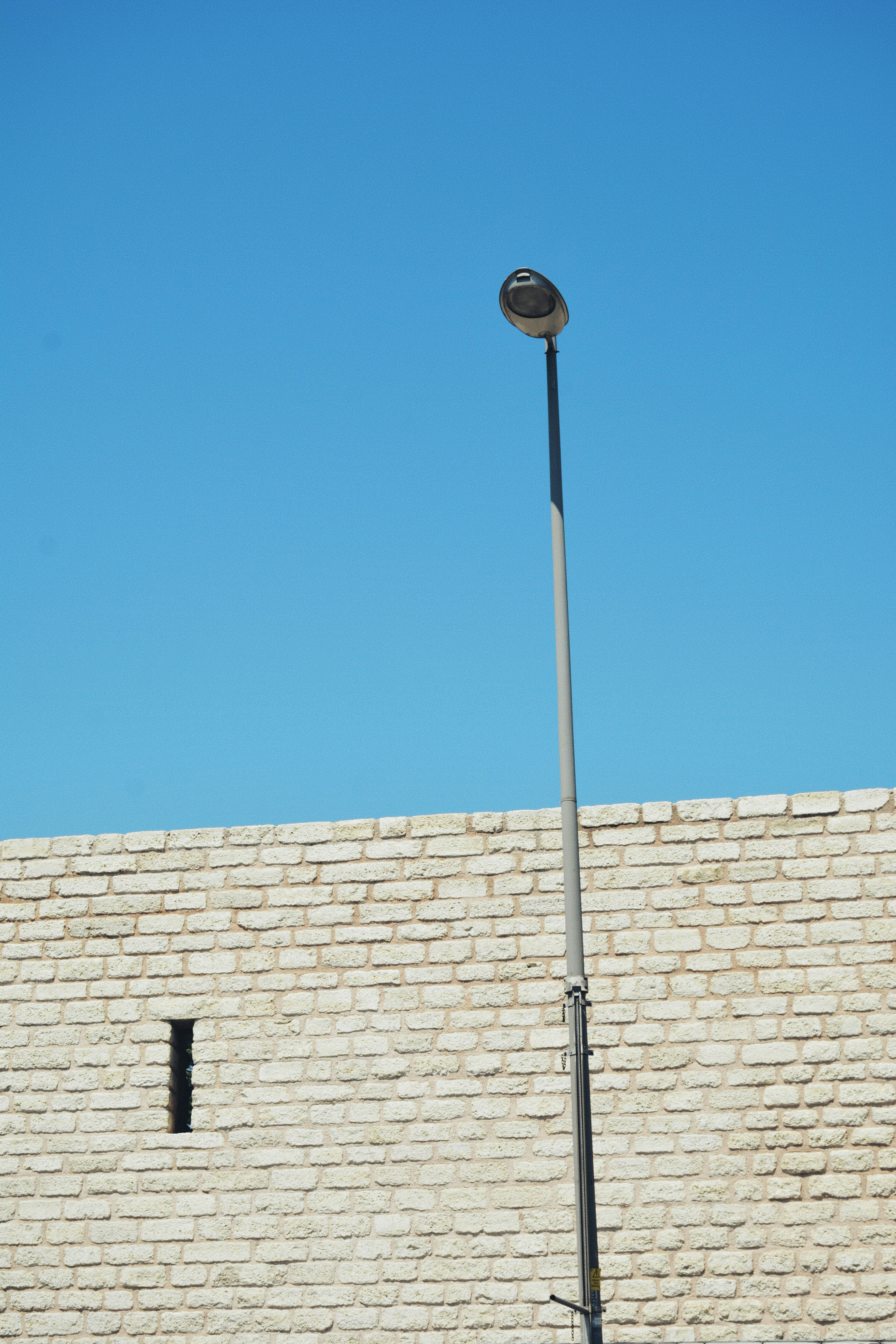 a light post on a brick wall