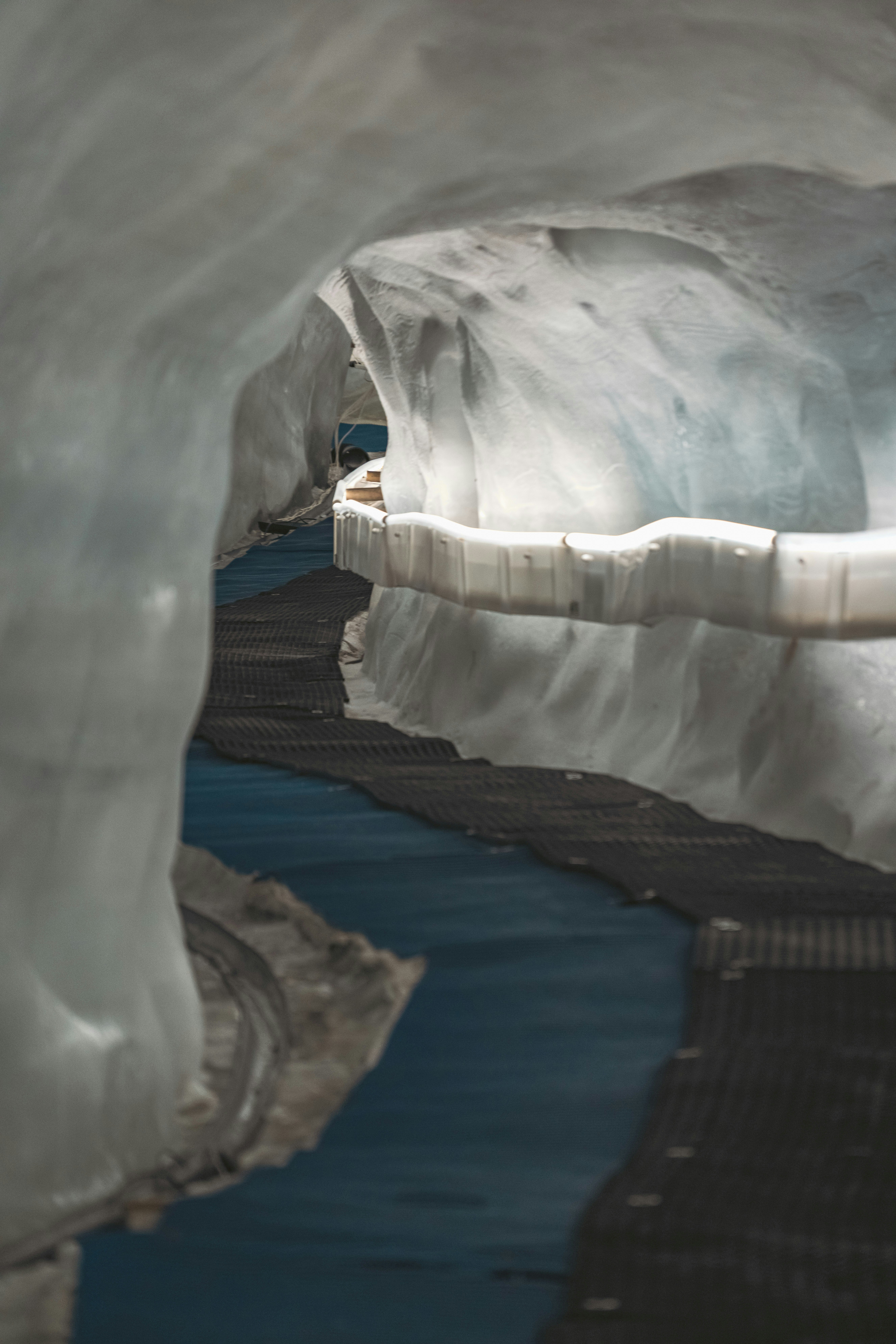 Glacial Corridor: A Snow Tunnel with Sculpted Ice and a Narrow Pathway
