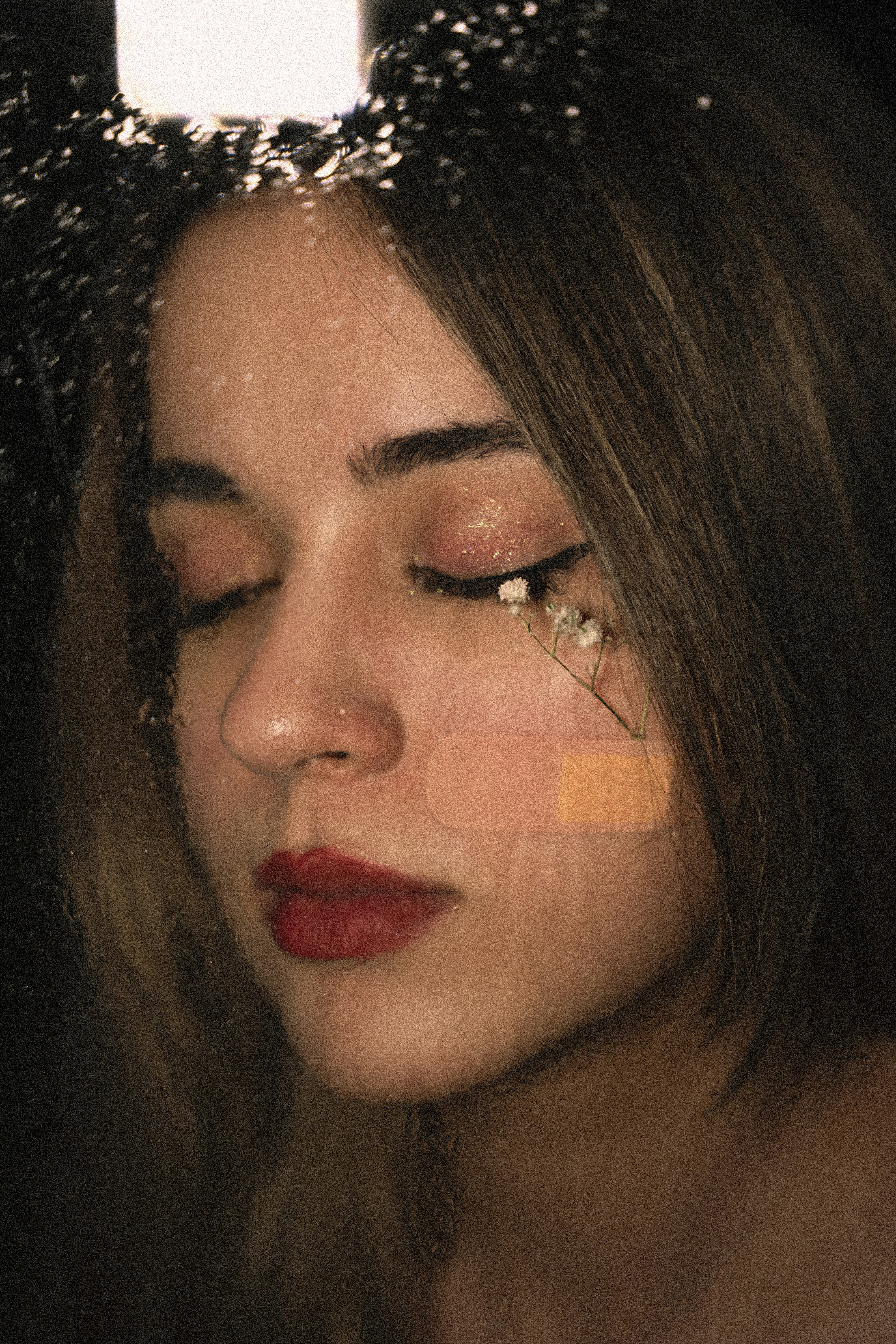 Velvet Quiet: Close-Up Portrait with a Tiny Bloom Under Warm Glow