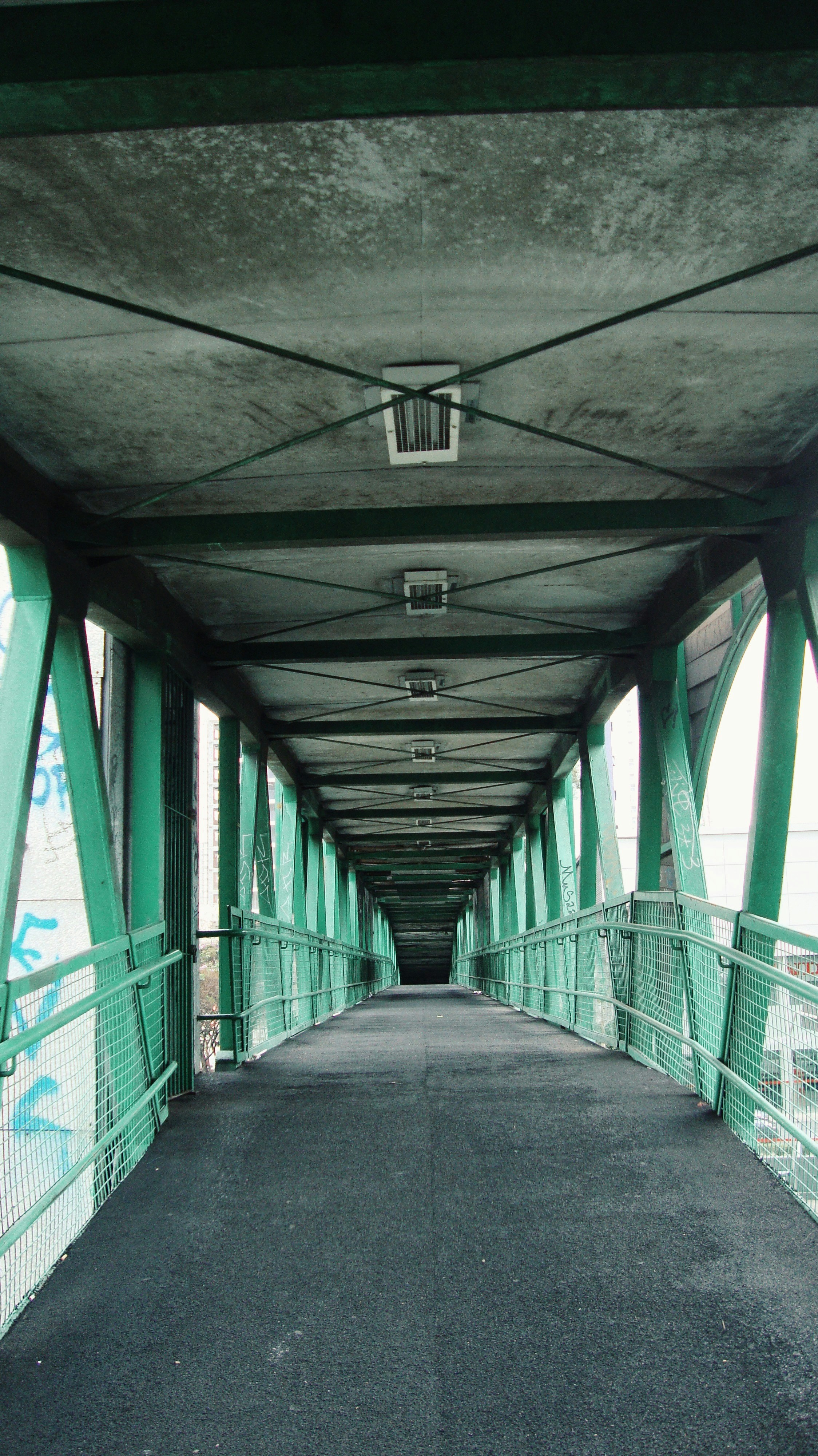 A tunnel with green railings photo – Free Building Image on Unsplash