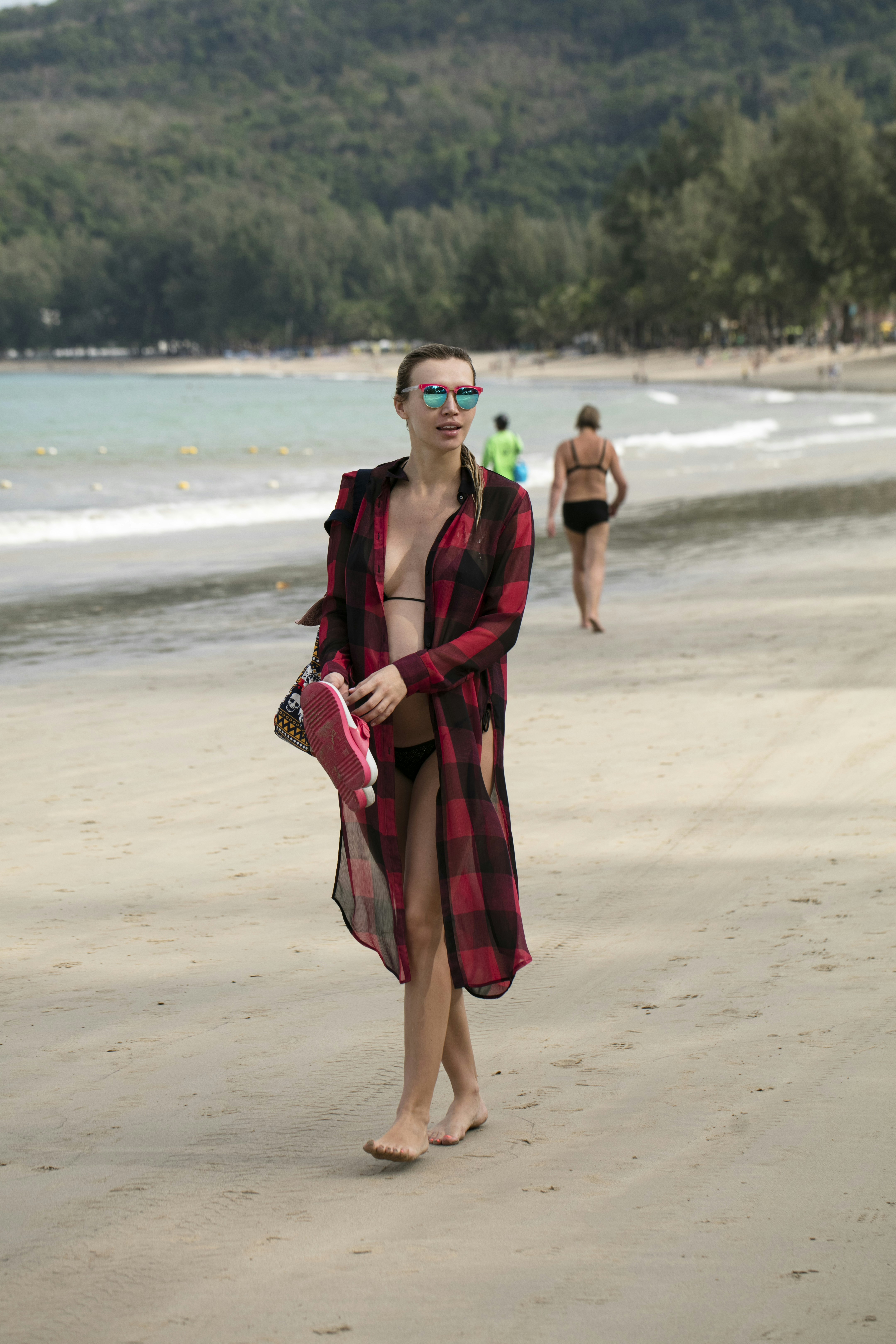 a person in a red dress on a beach
