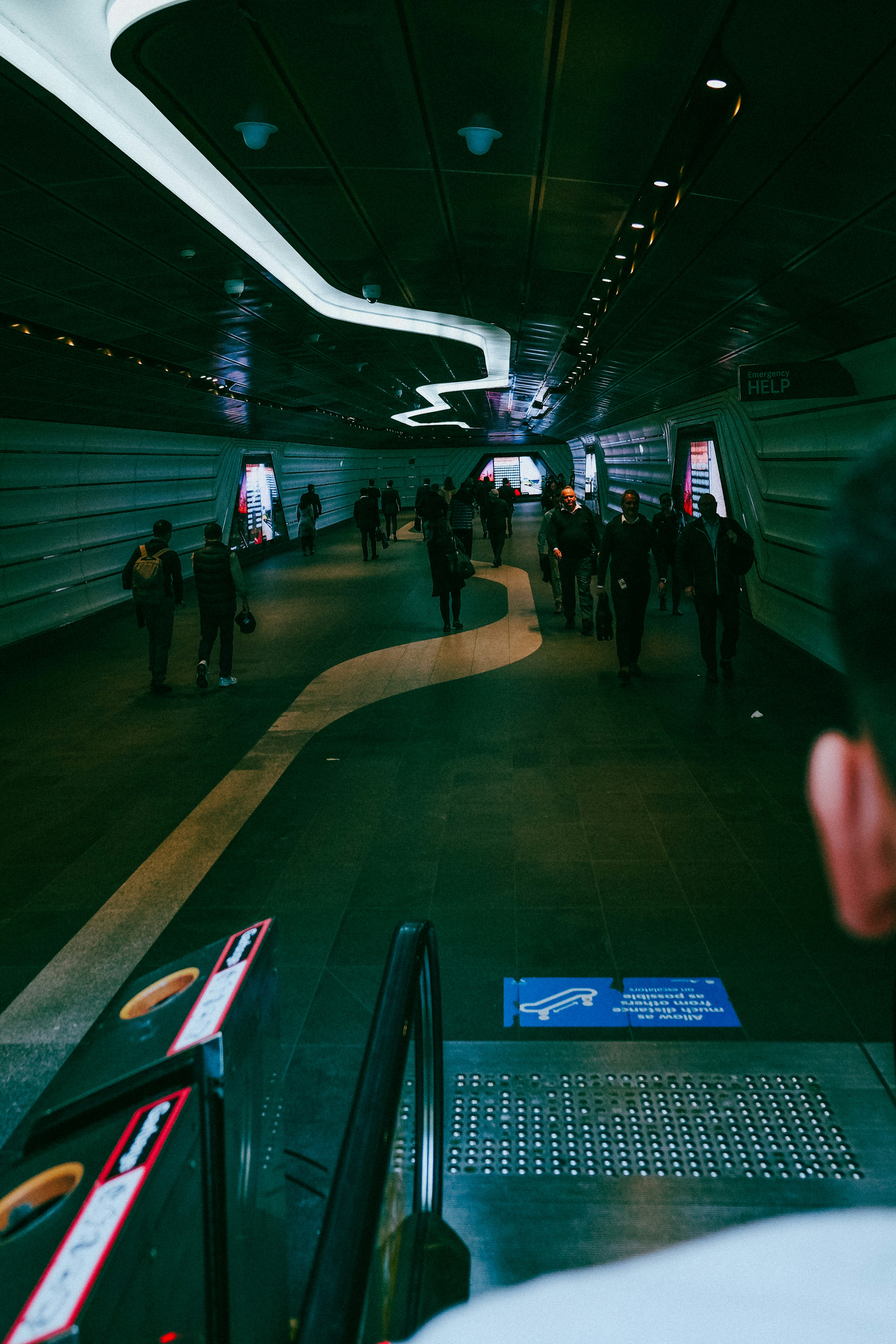 Green-Tinted Passage: Pedestrians Flow Toward the Bright Exit