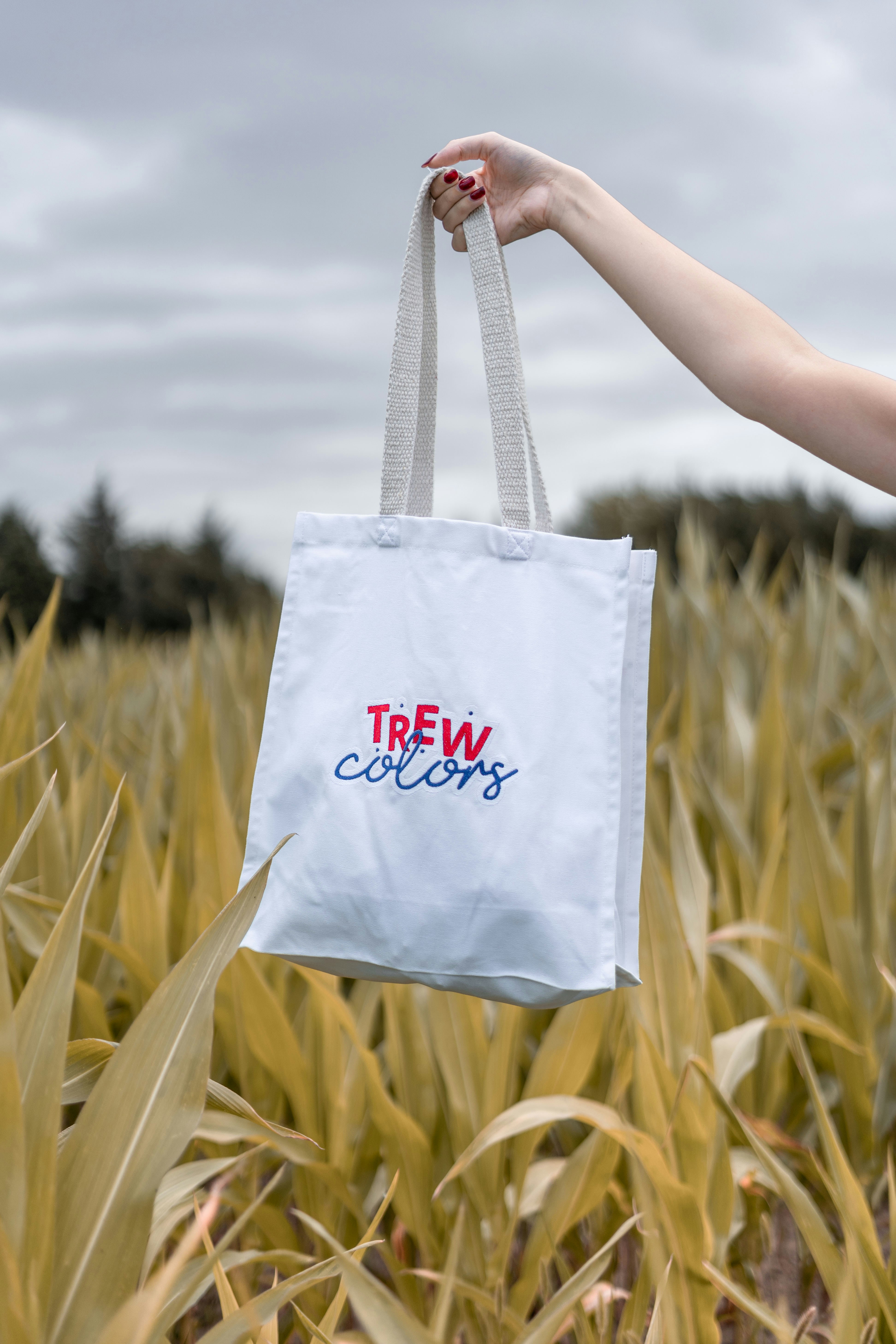 Hand-loomed tote hovering above a cornfield canvas