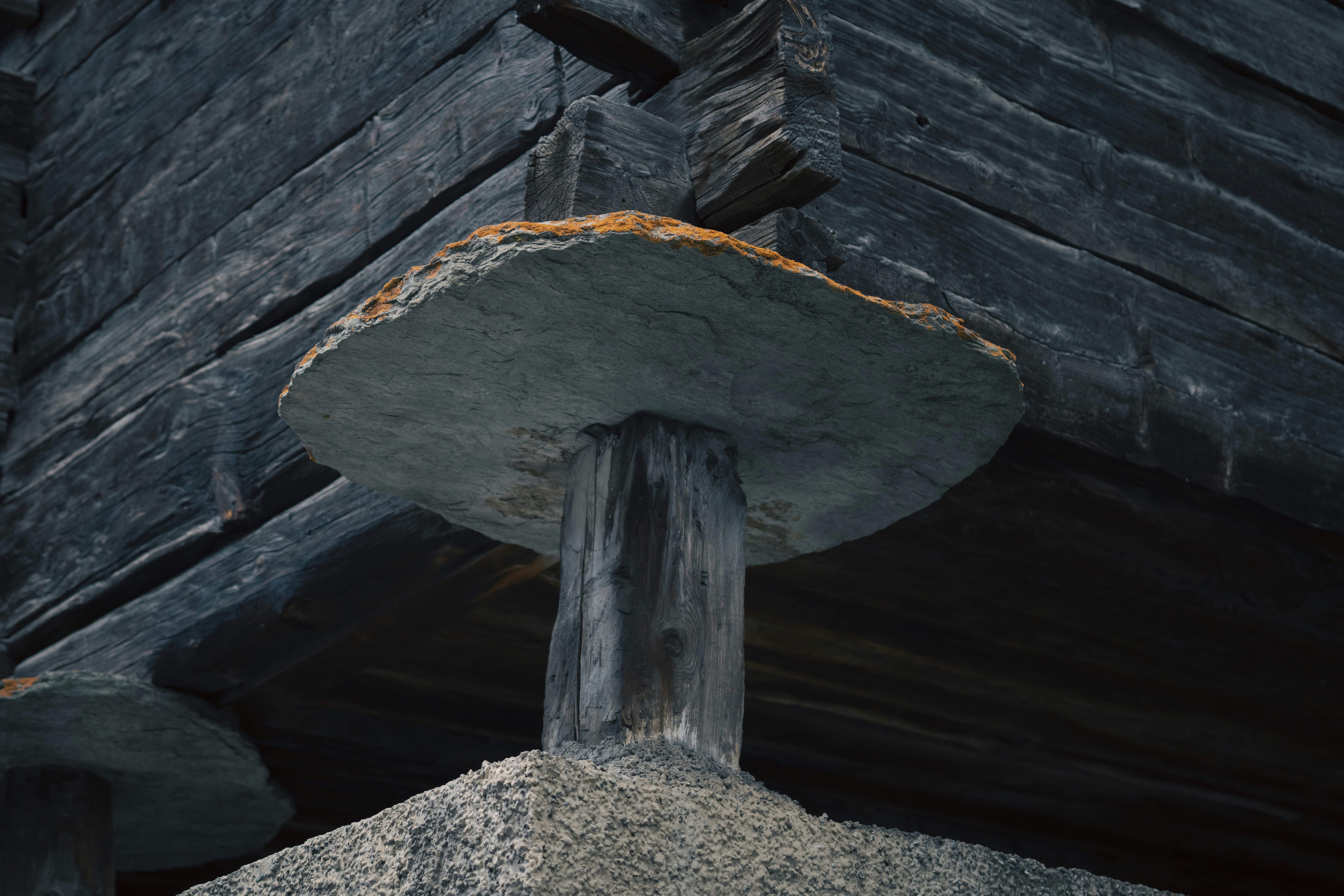Mushroom-Cap Monument: A Stone Pillar Beneath Weathered Timber
