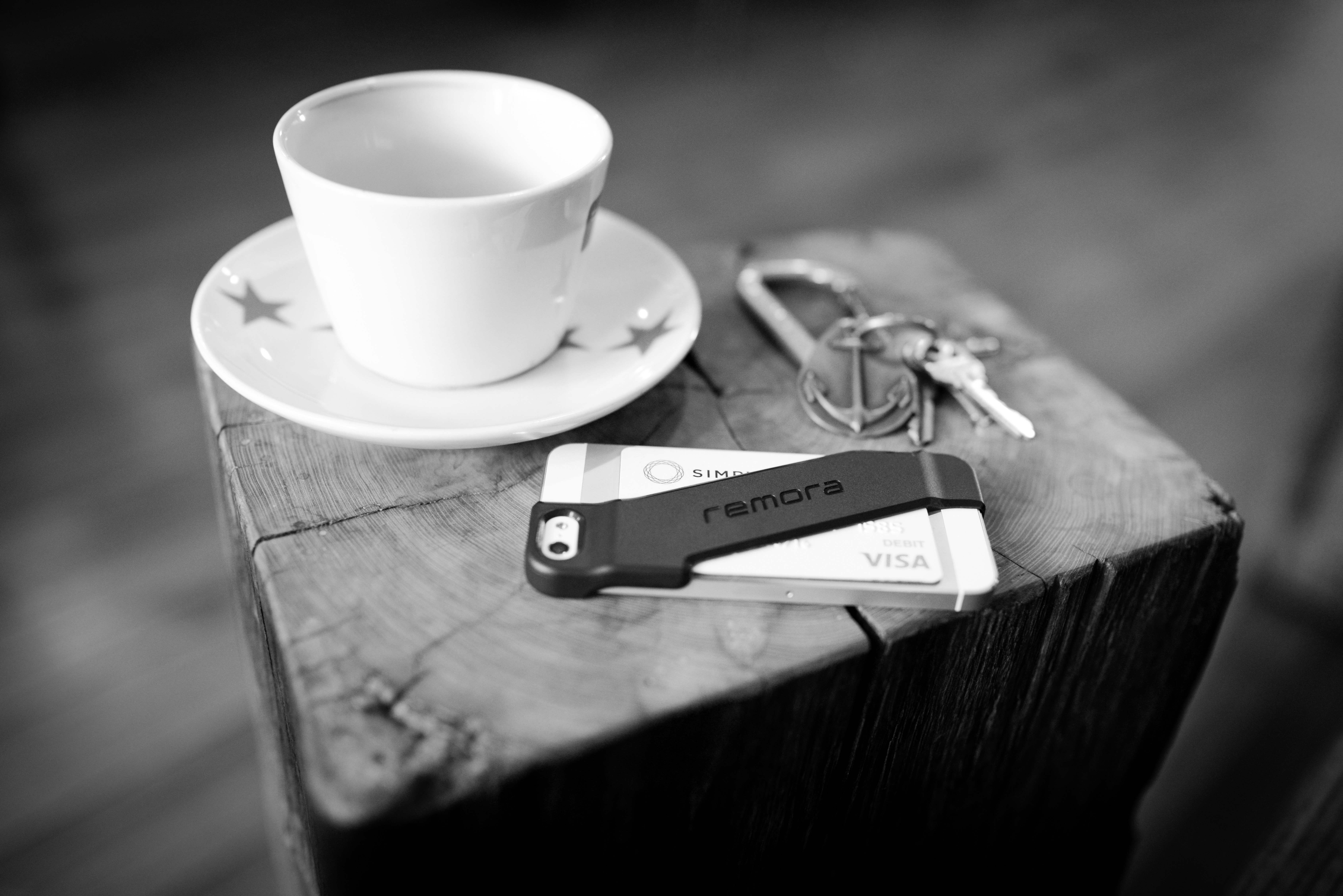 Coffee on Wood: A Moment with a Card Reader and Keys on a Weathered Post