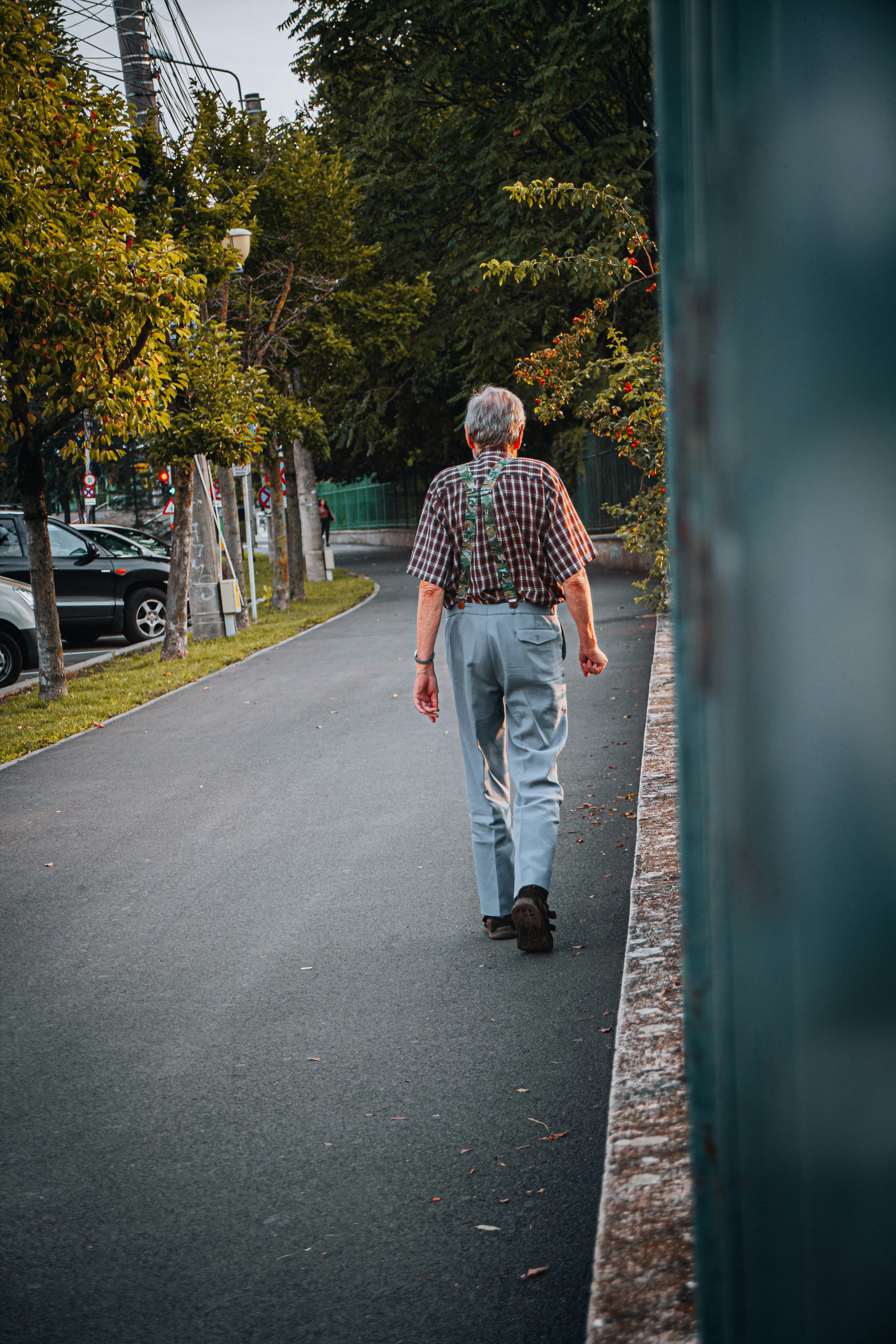 Suspenders on a Quiet Path: A Man Walks Away
