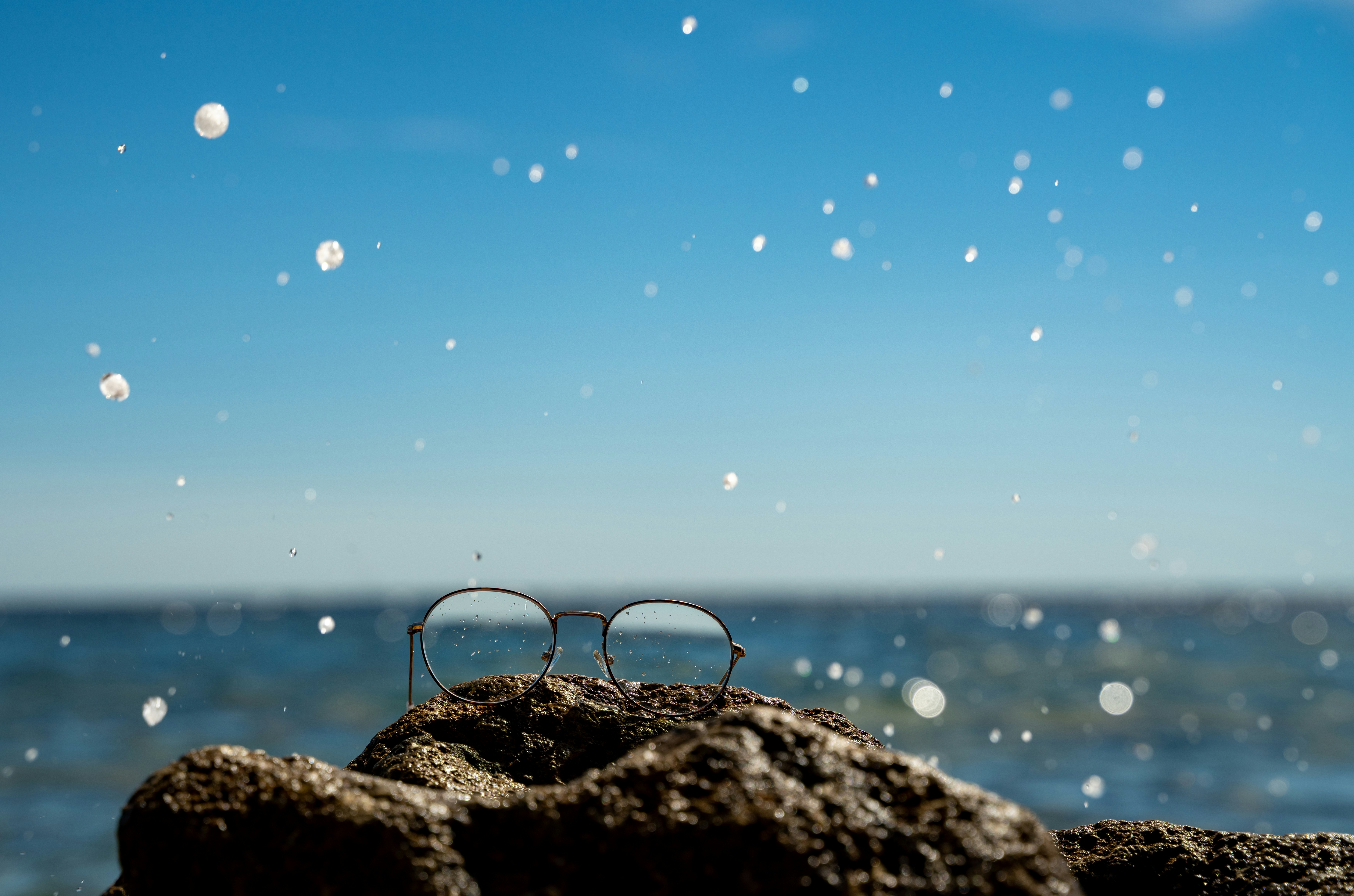 Glasses on a rock in front of the sea