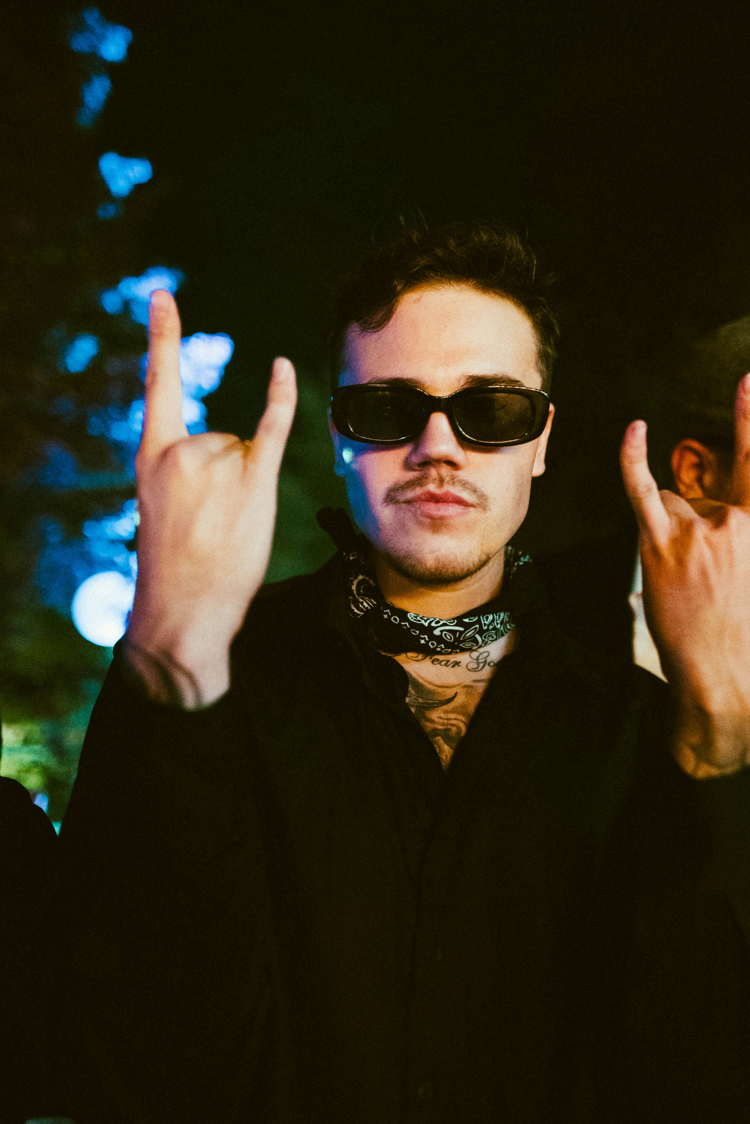 A man wearing sunglasses and holding up his middle finger photo – Free ...