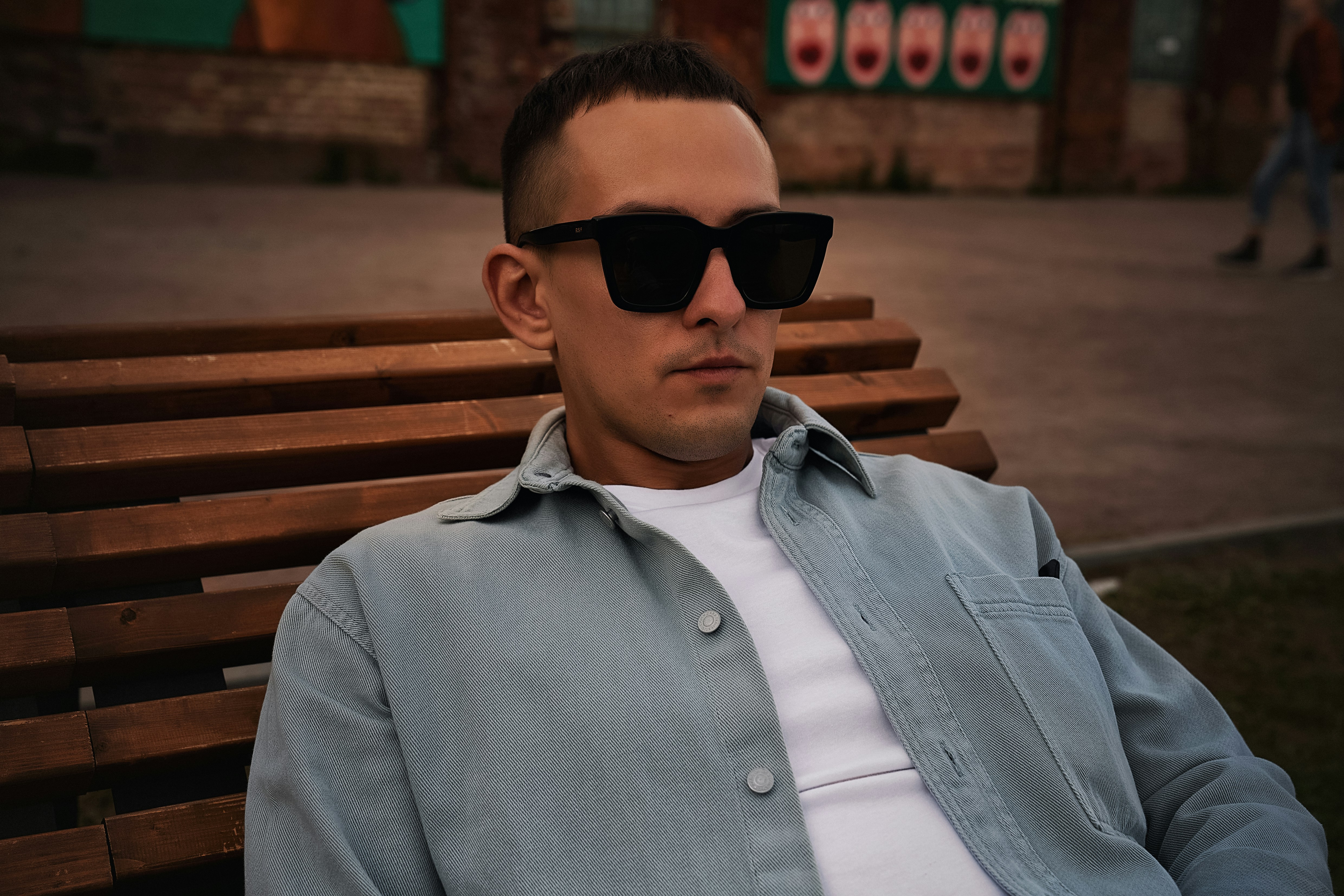 Sunglasses and Stillness: A Quiet Portrait on a Park Bench