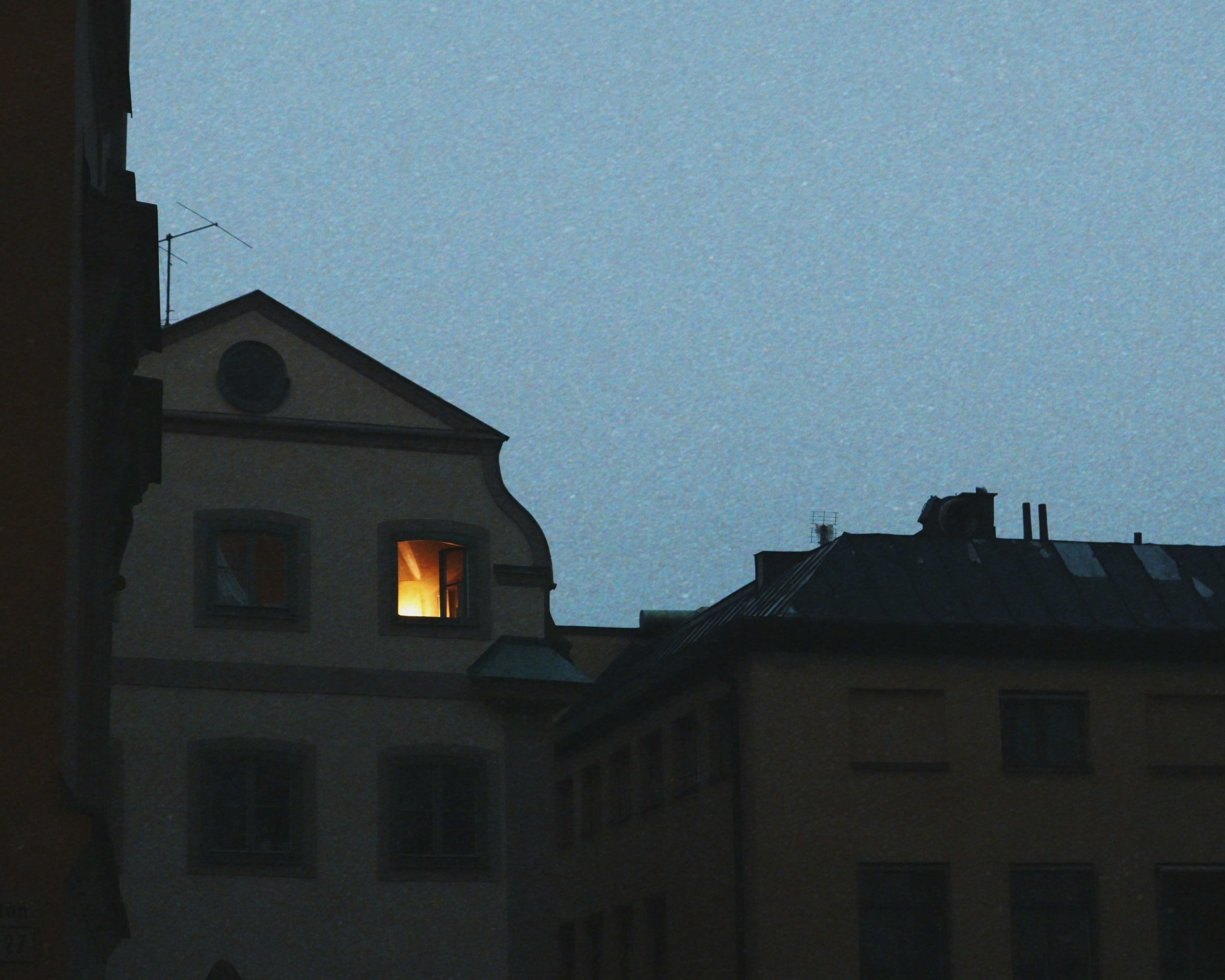 Amber Window in a Quiet City at Dusk
