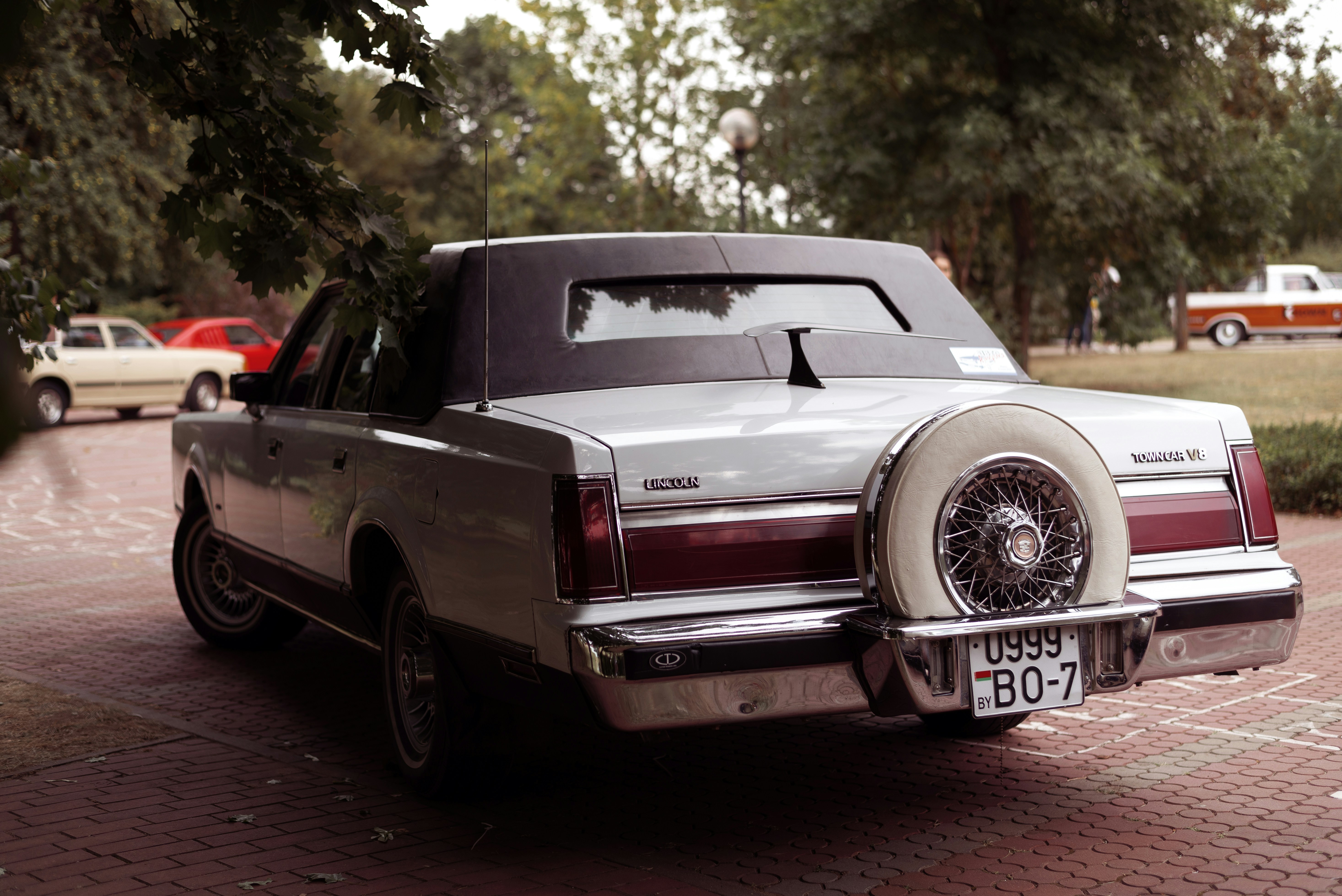 a silver car parked on a brick road