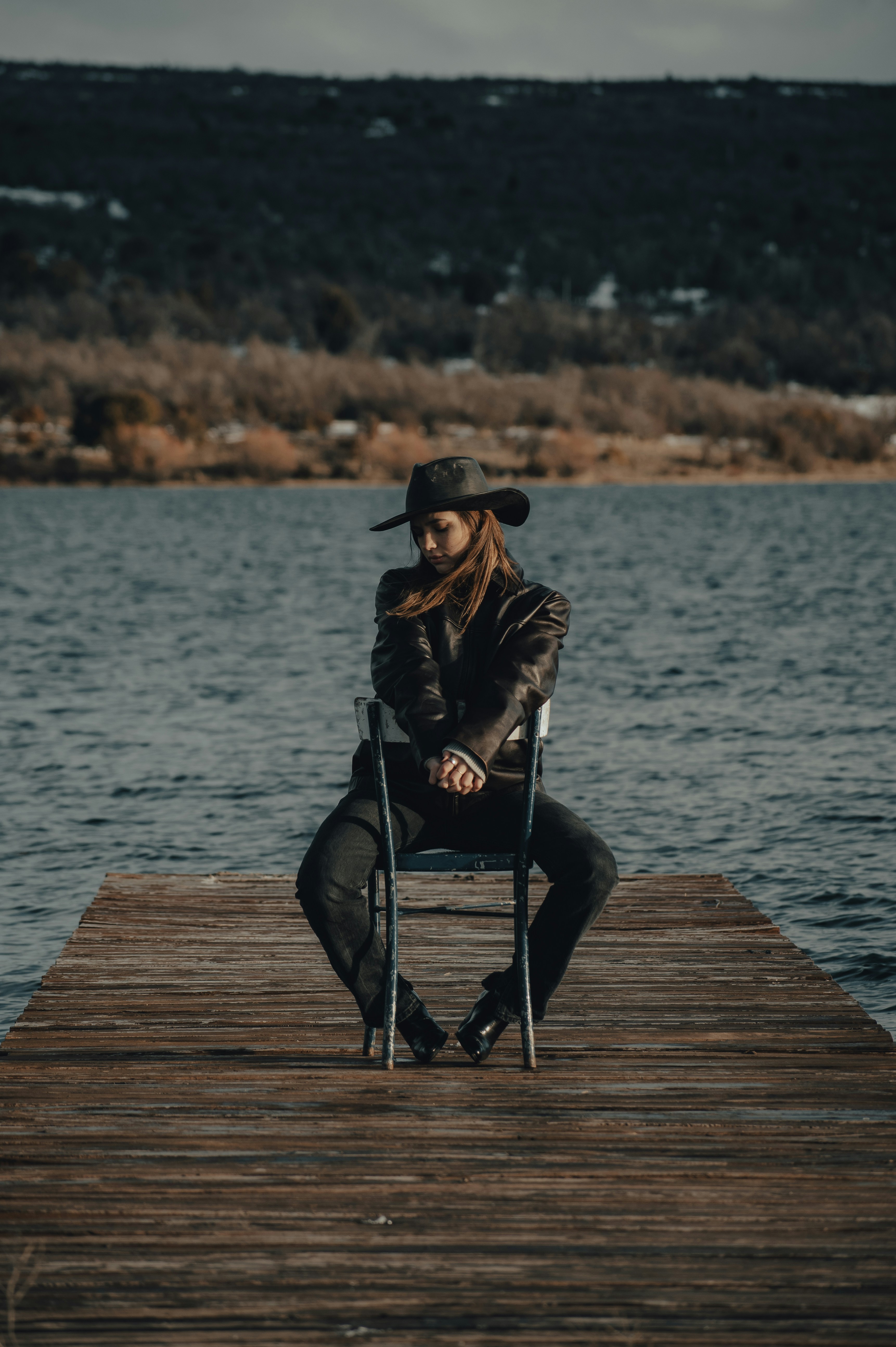 A person sitting on a dock photo – Free Grey Image on Unsplash