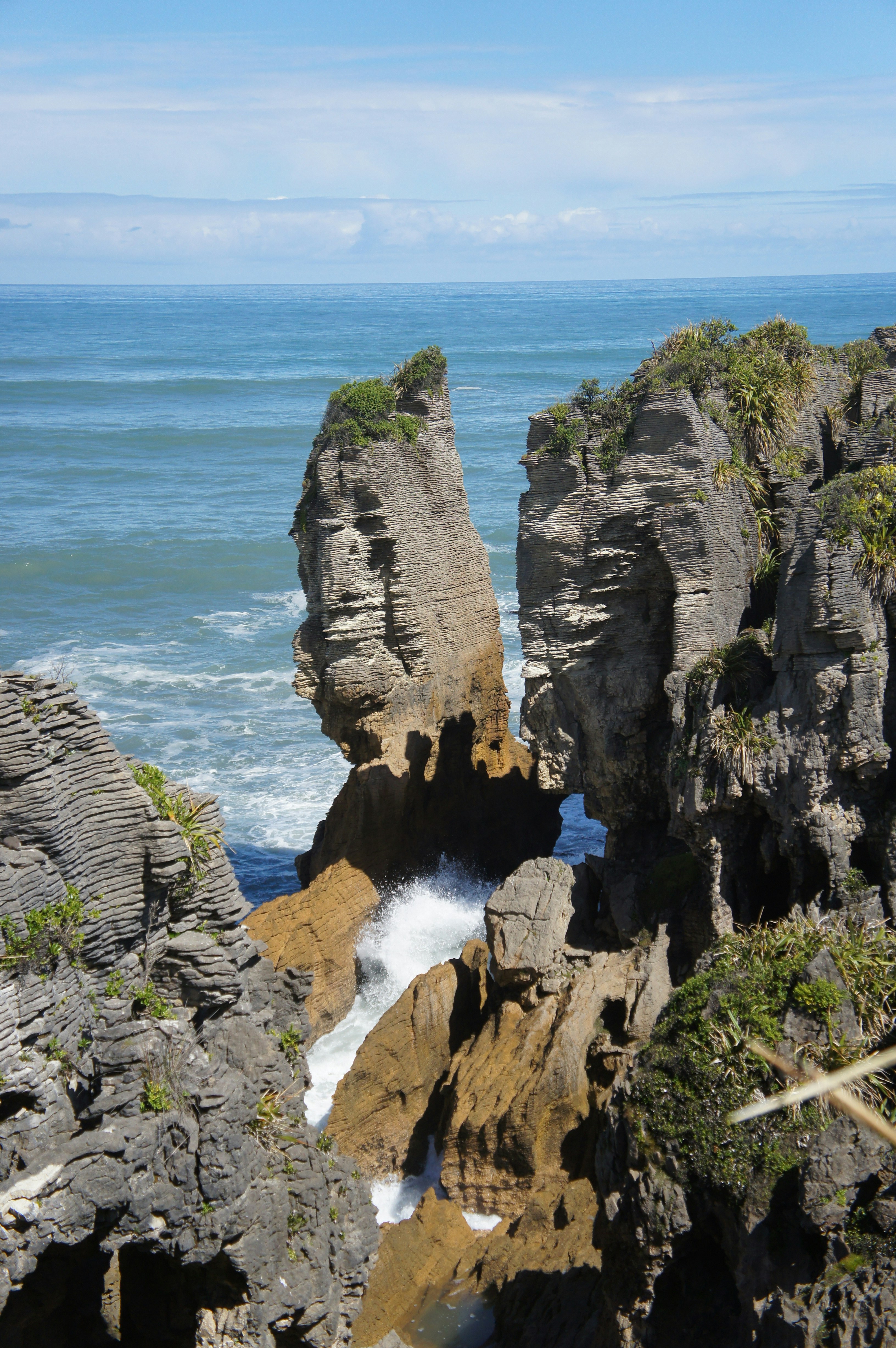 Sea Arch Cliffscape: Towering Rocks Framed by Ocean Blues