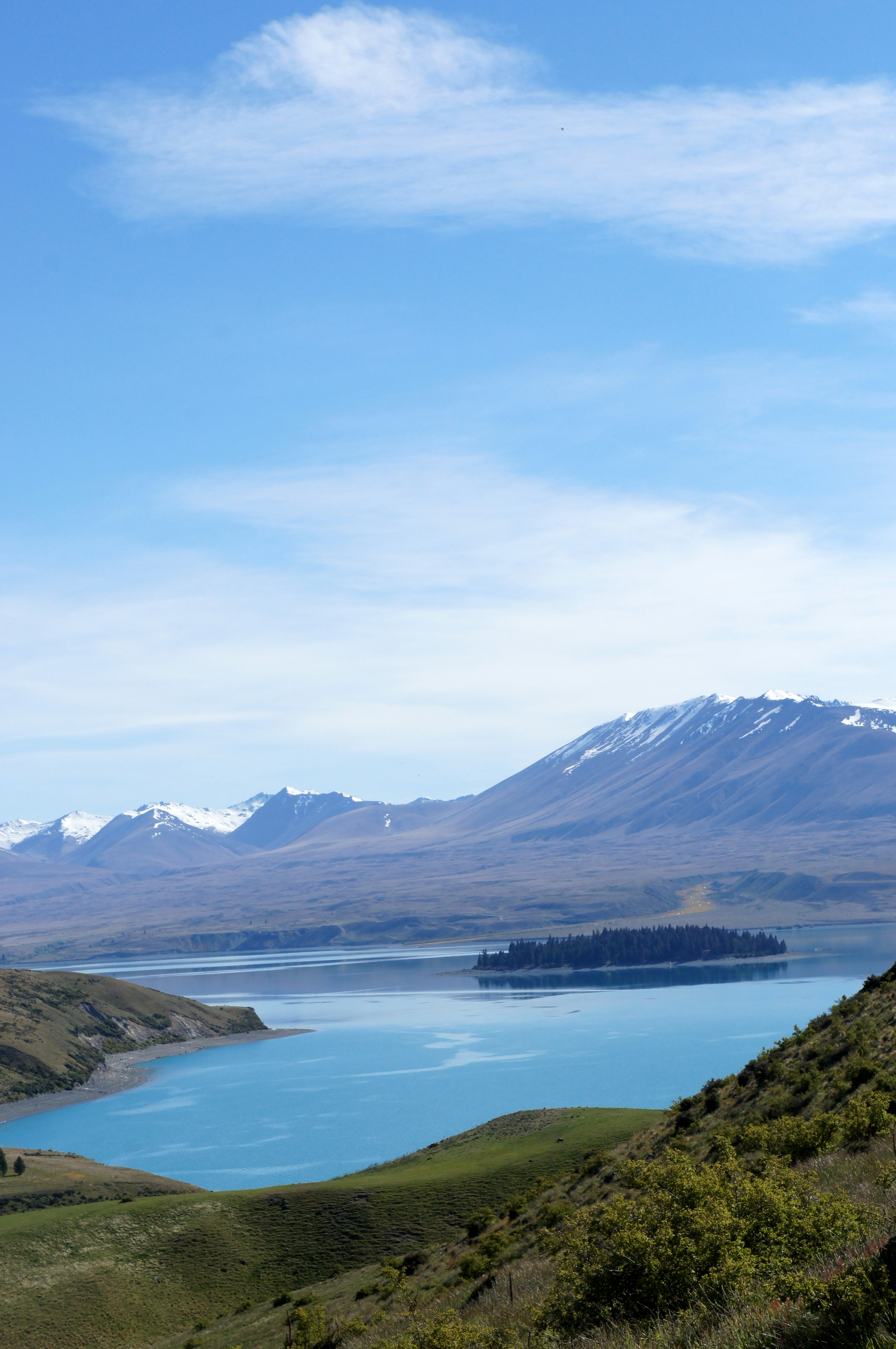 A body of water with mountains in the background photo – Free Land ...