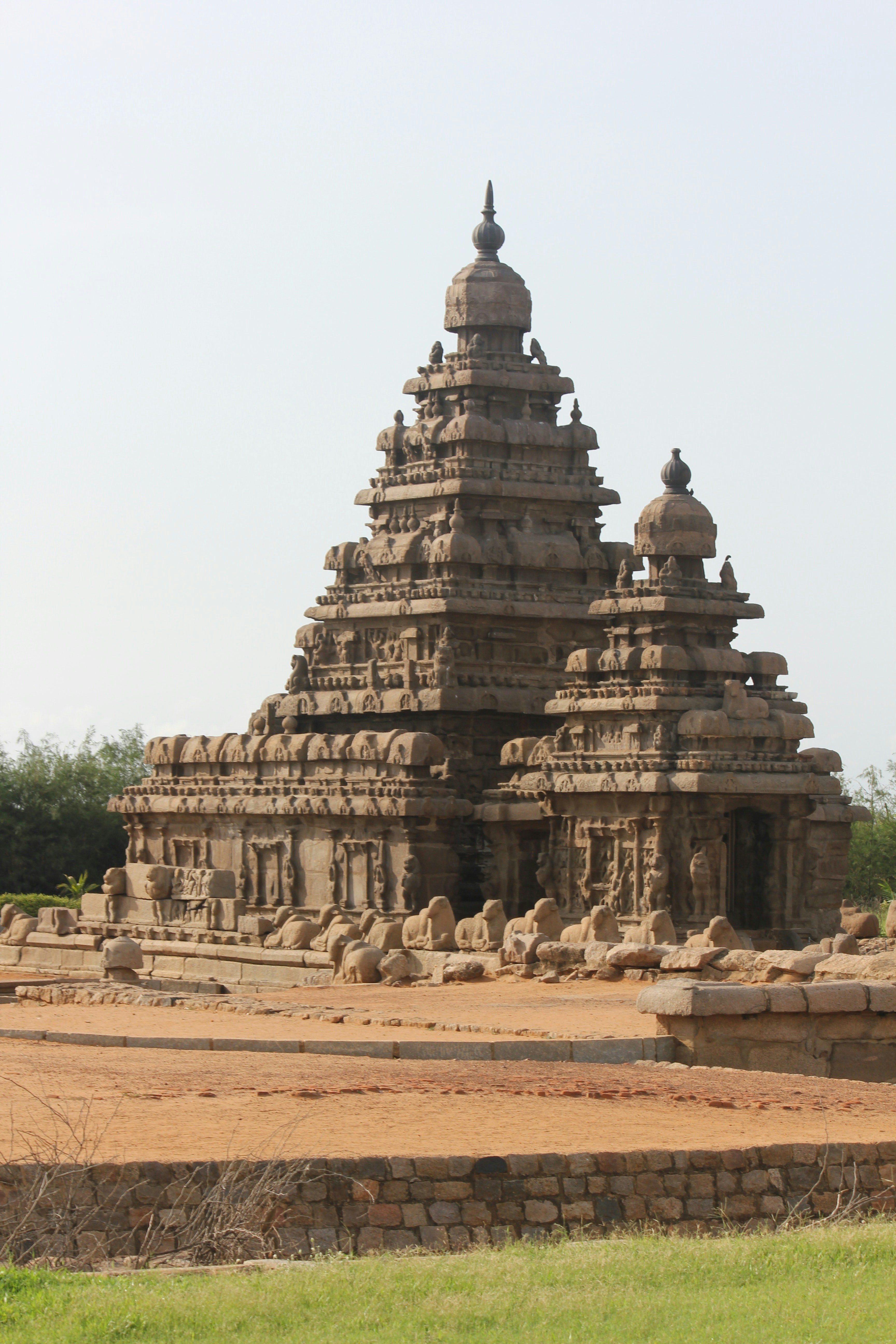 A large stone building with Mahabalipuram in the background photo ...