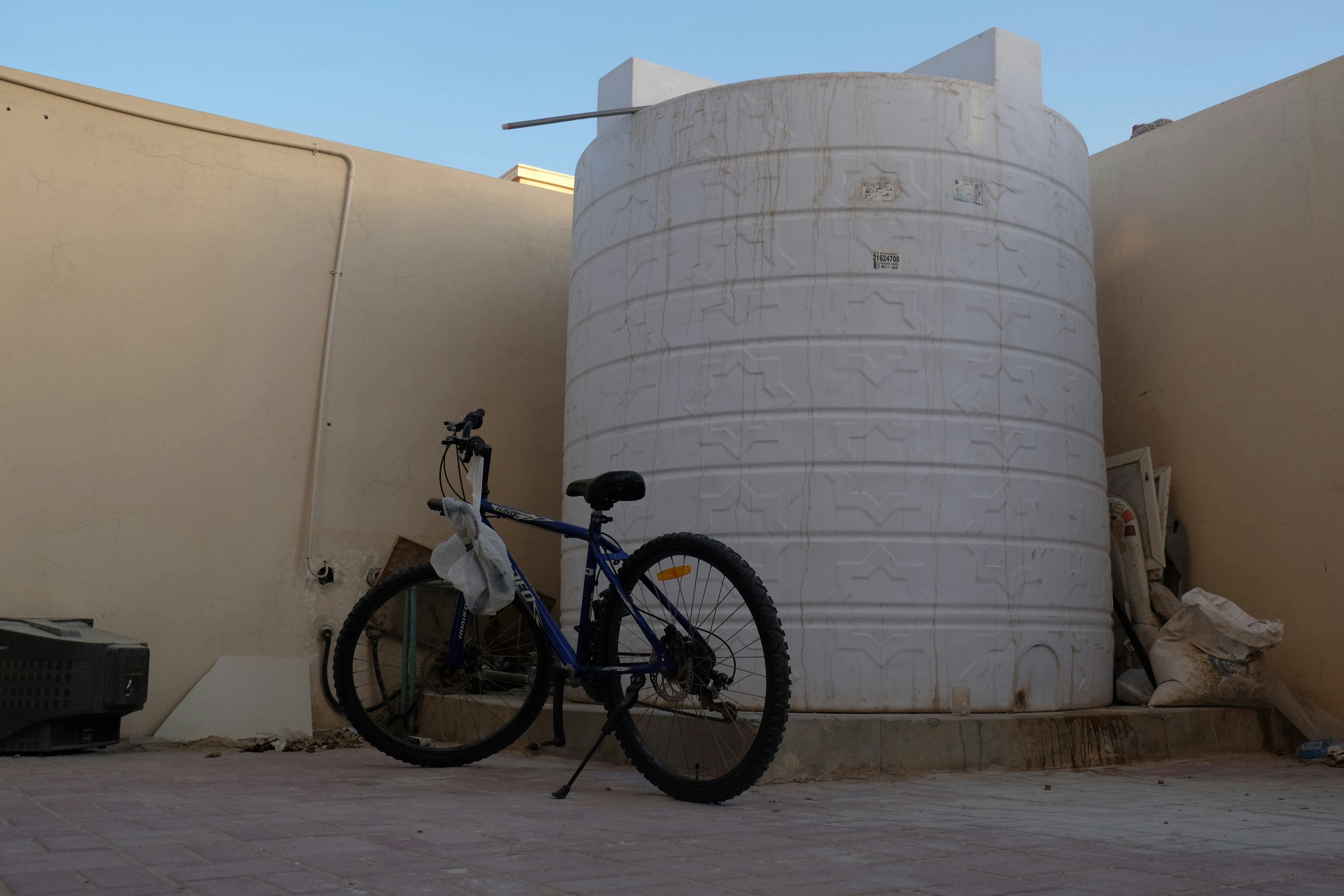 a bicycle parked in front of a large white building