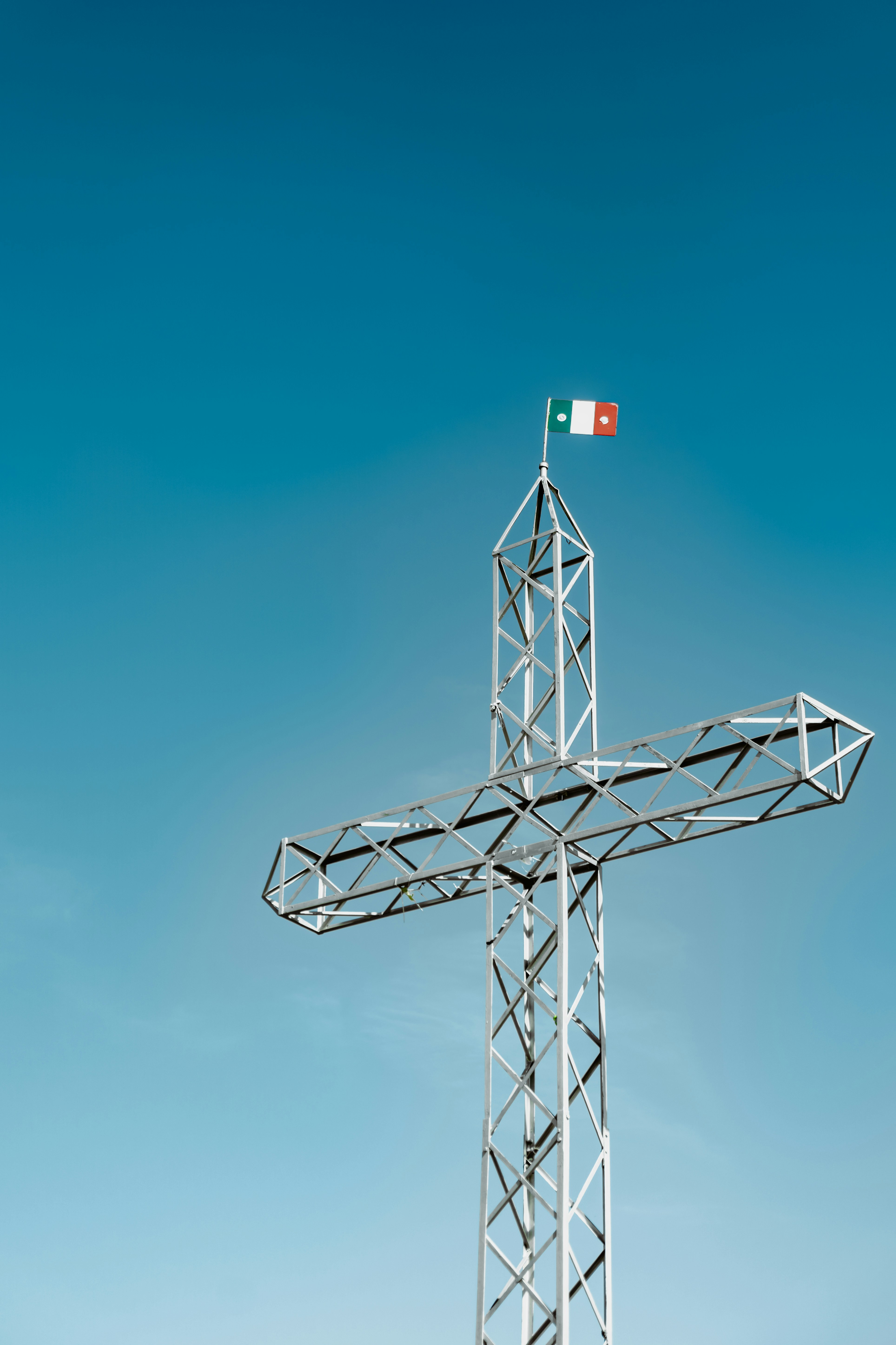 A tall metal tower with flags photo – Free Italy Image on Unsplash