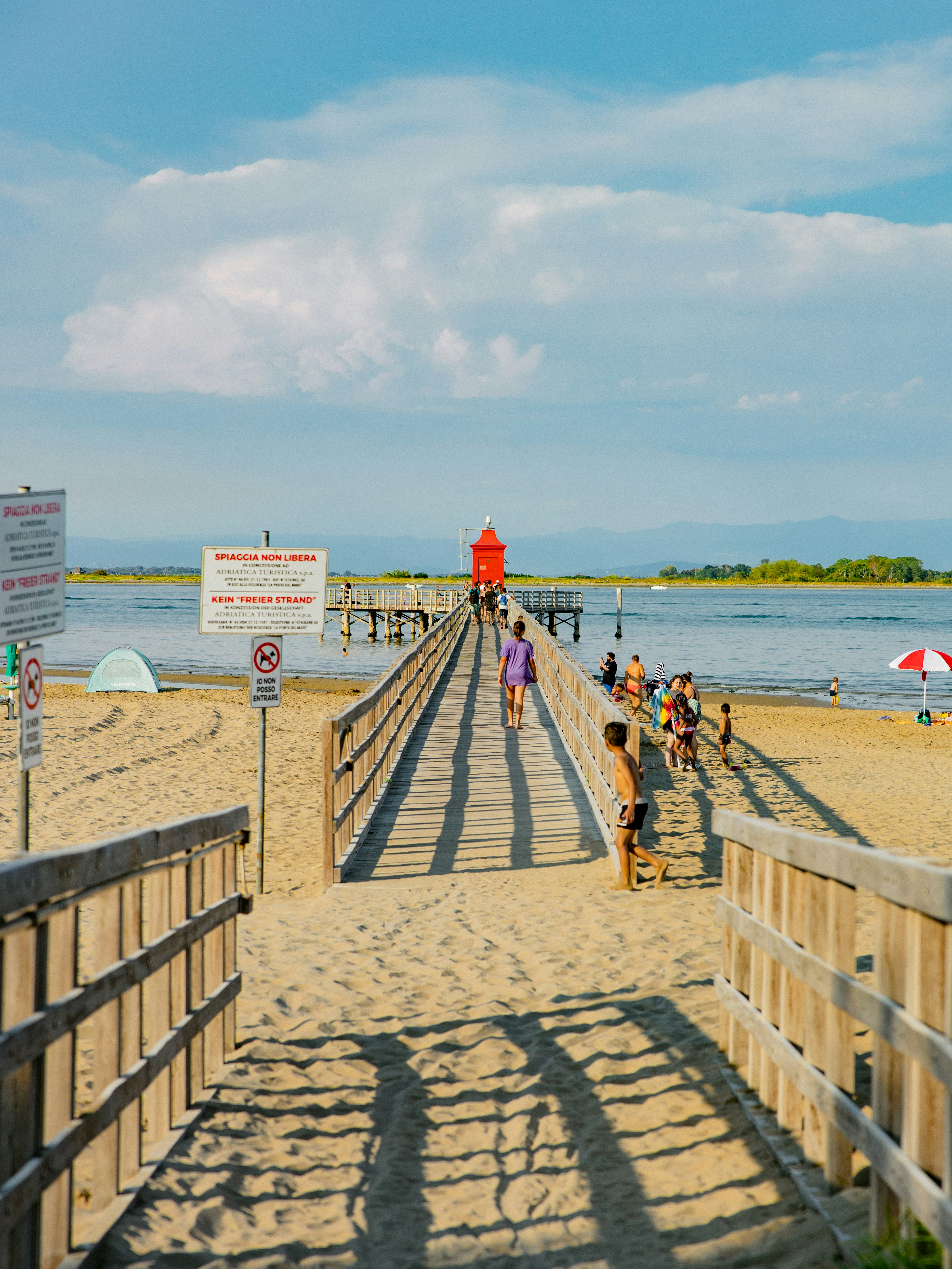 A group of people walking on a boardwalk photo – Free People Image on ...