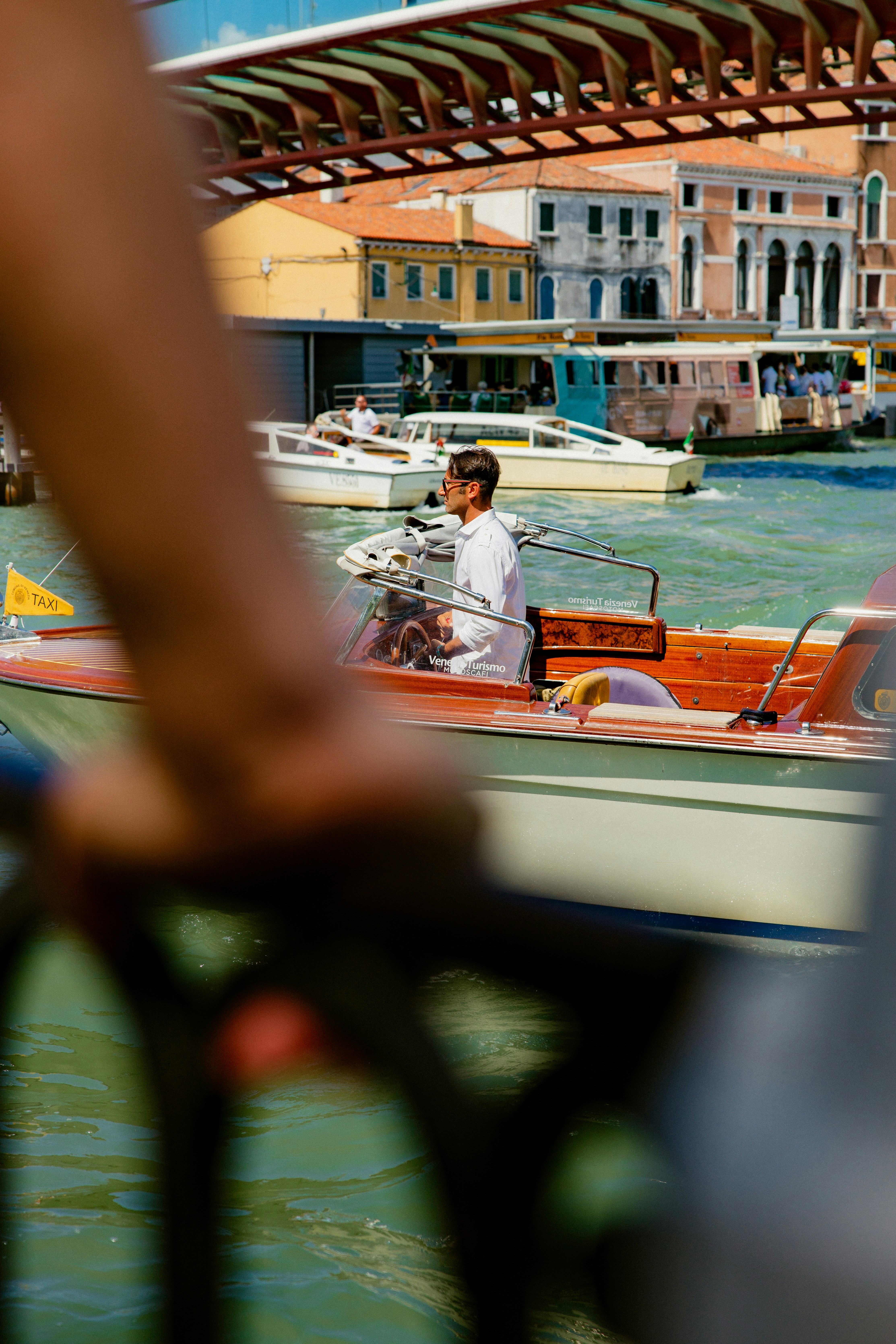 Masked Helm in a Venetian Channel: A Sunlit Boat Scene