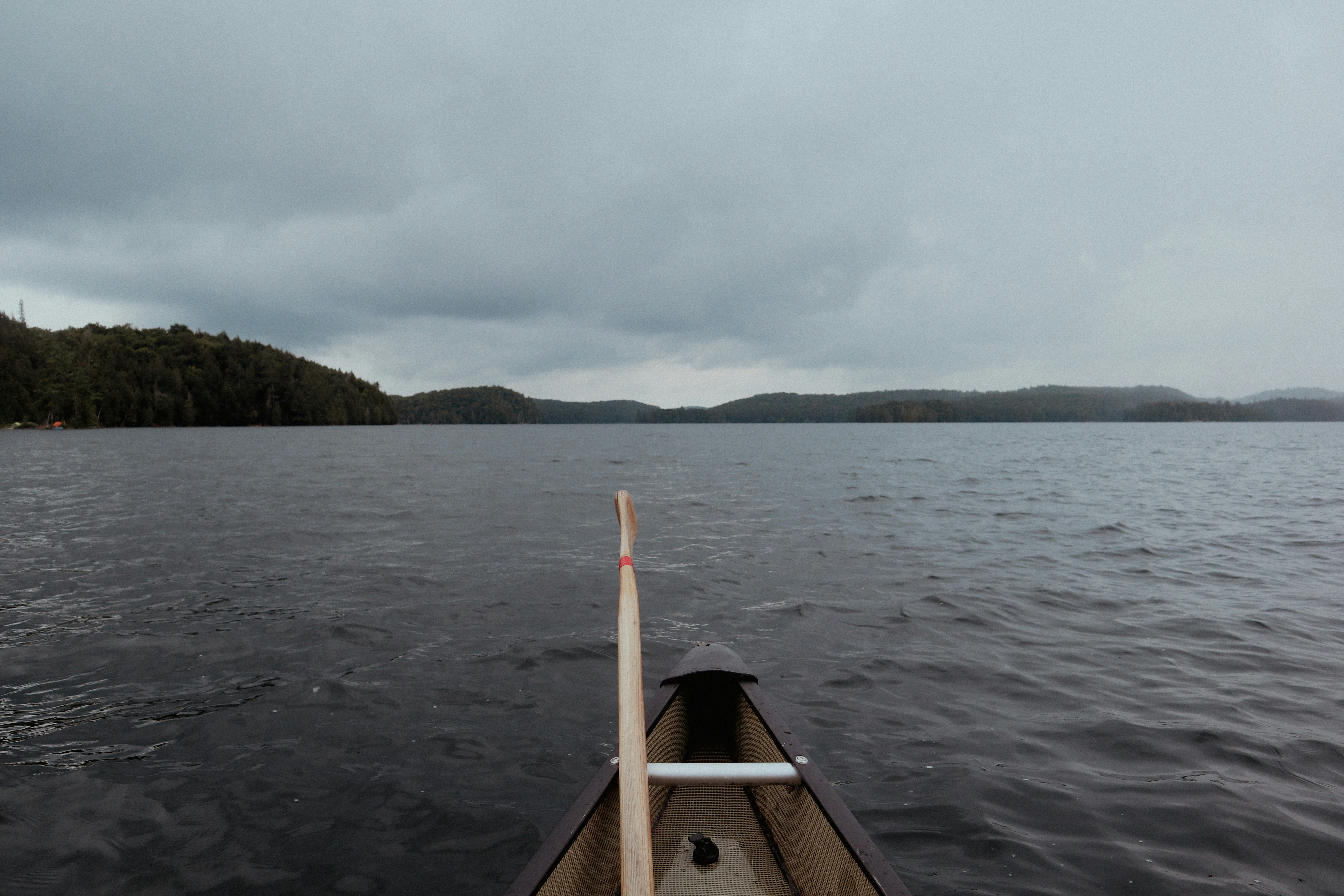 Paddling Toward the Distant Crest on a Quiet Lake