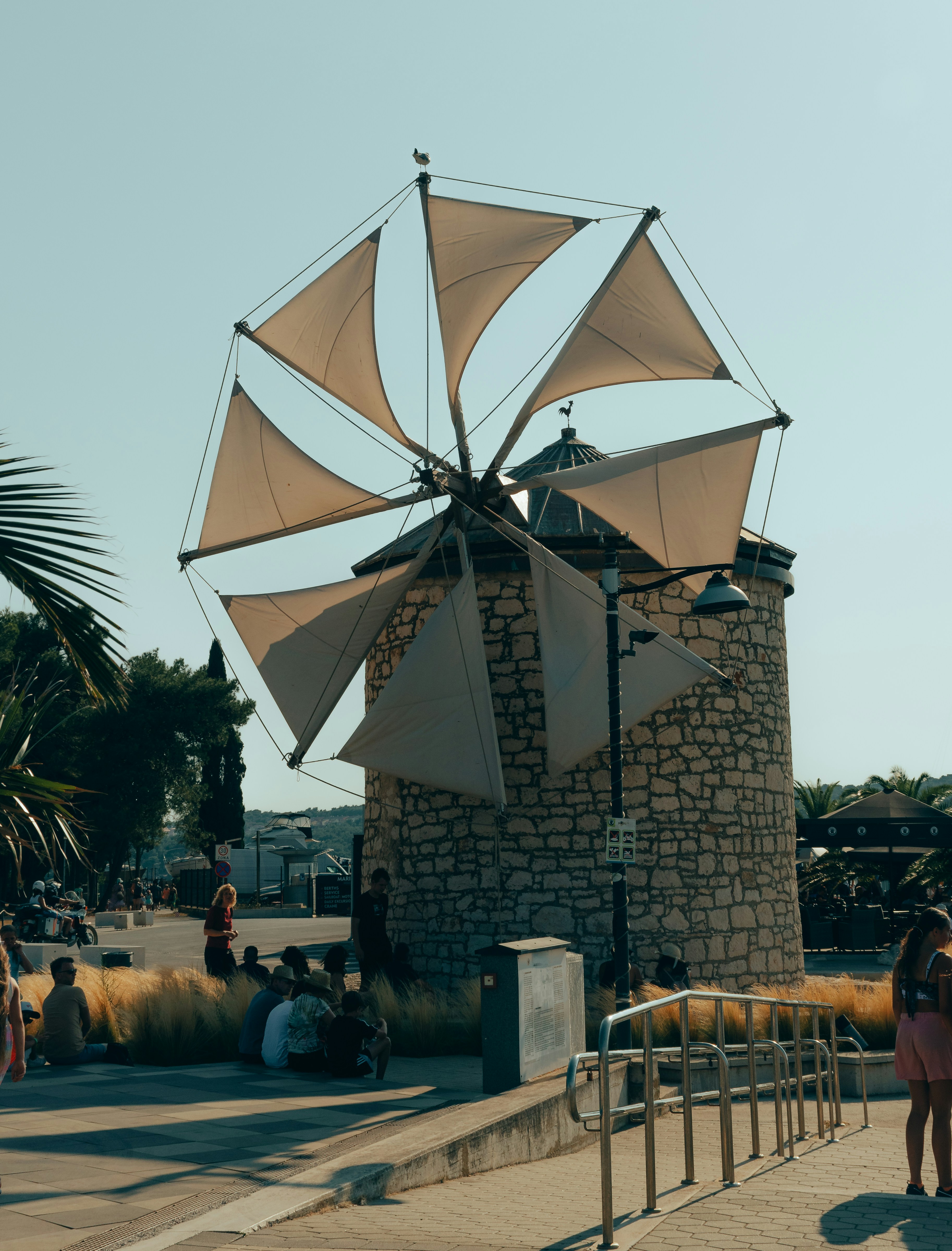 Sailwind Sculpture Anchored to a Seaside Stone Turret