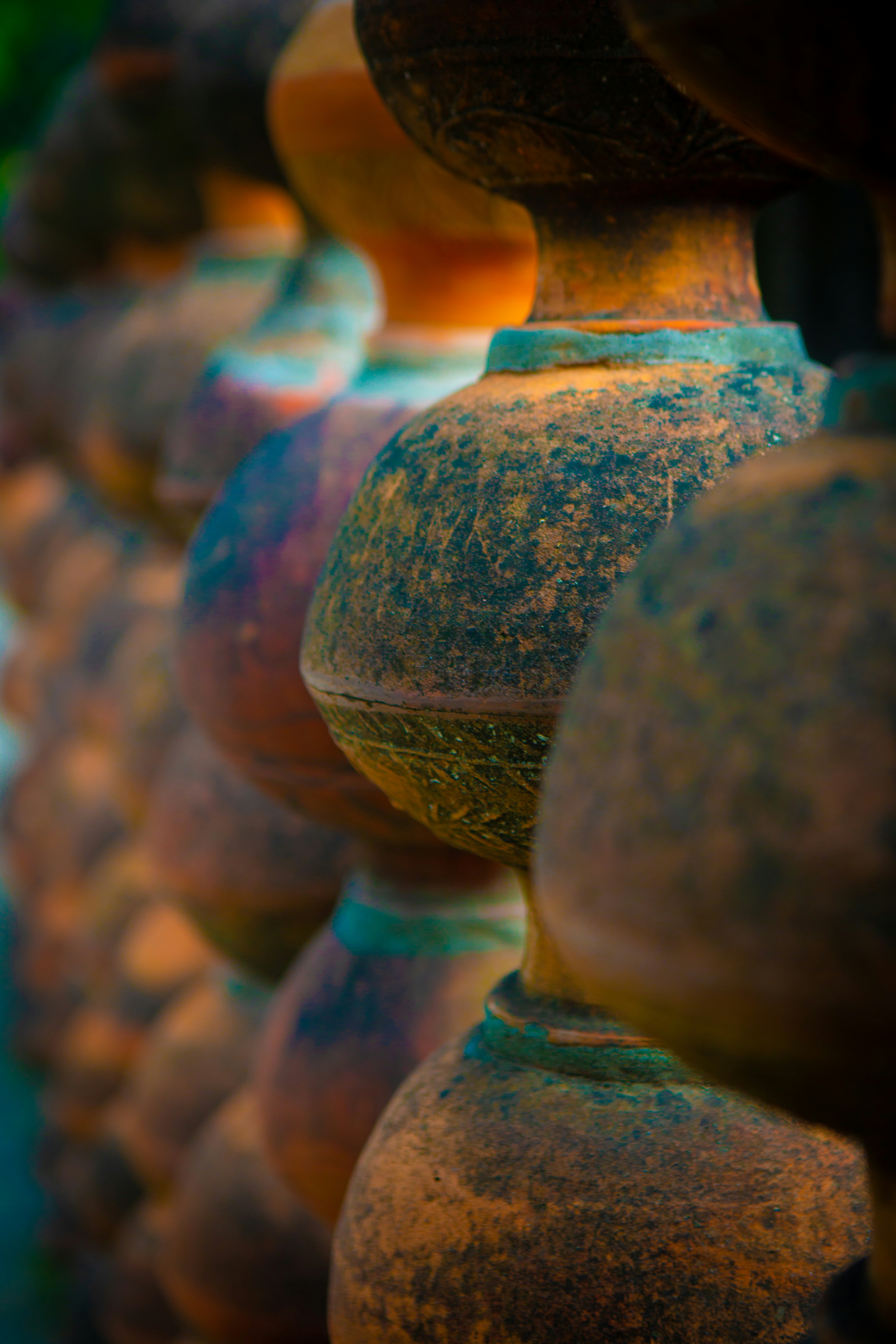 Dust-Kissed Terracotta Row: A Close-Up of Patinated Vases in Soft Focus
