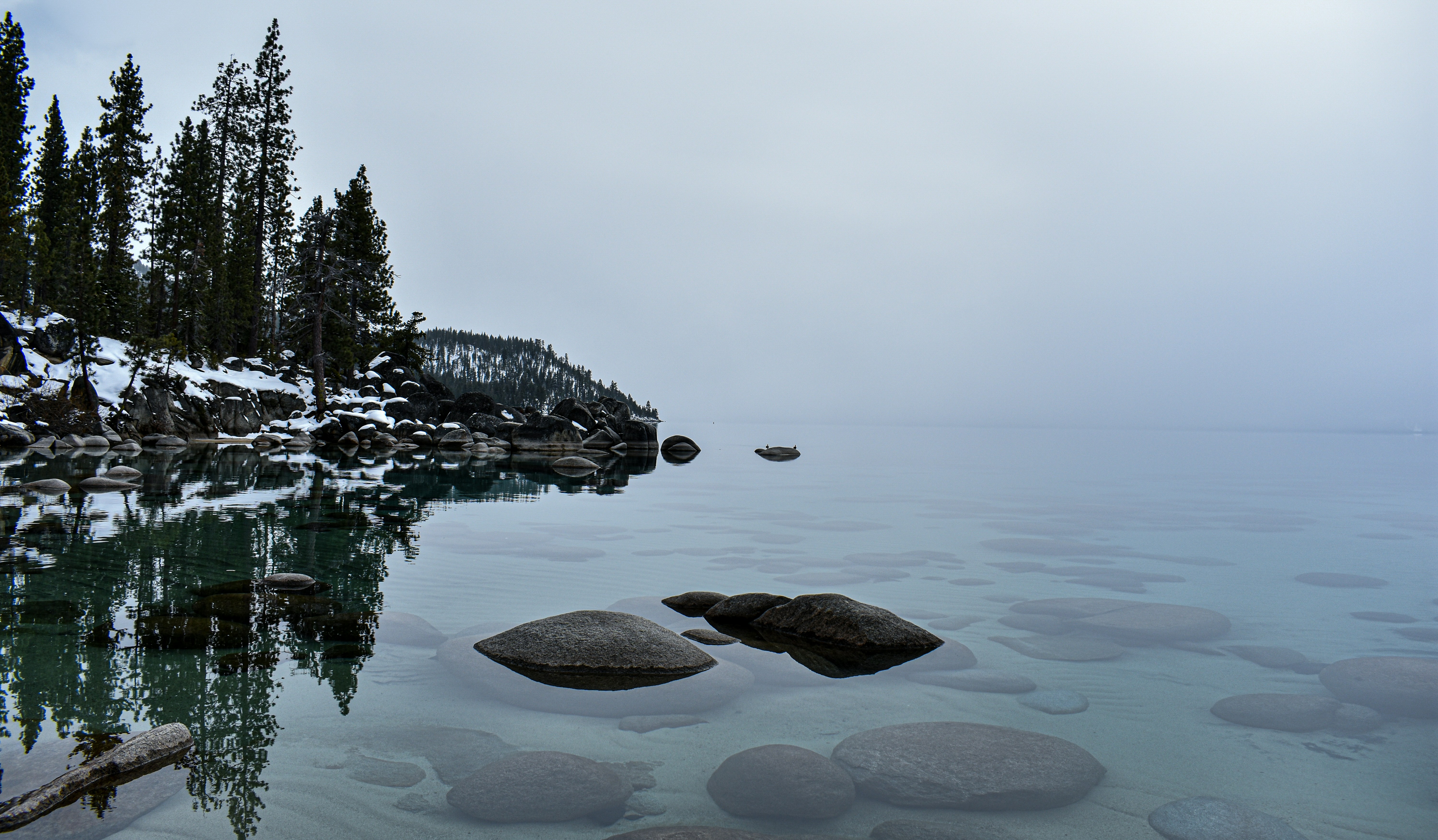 Hushed Lake: Granite Orbs in Glassy Turquoise Waters